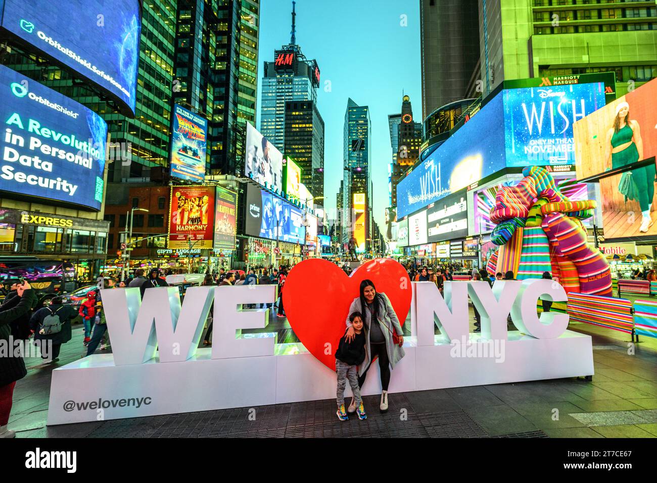 New York, USA. , . People pose by a "We Love NYC sign" in front of ...