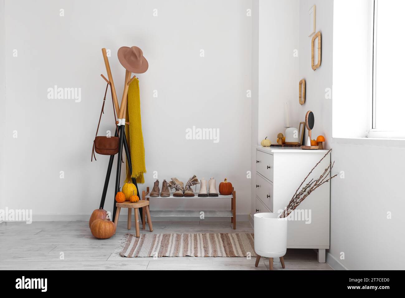 Interior of cozy hall with pumpkins, clothes rack and shoe stand Stock ...