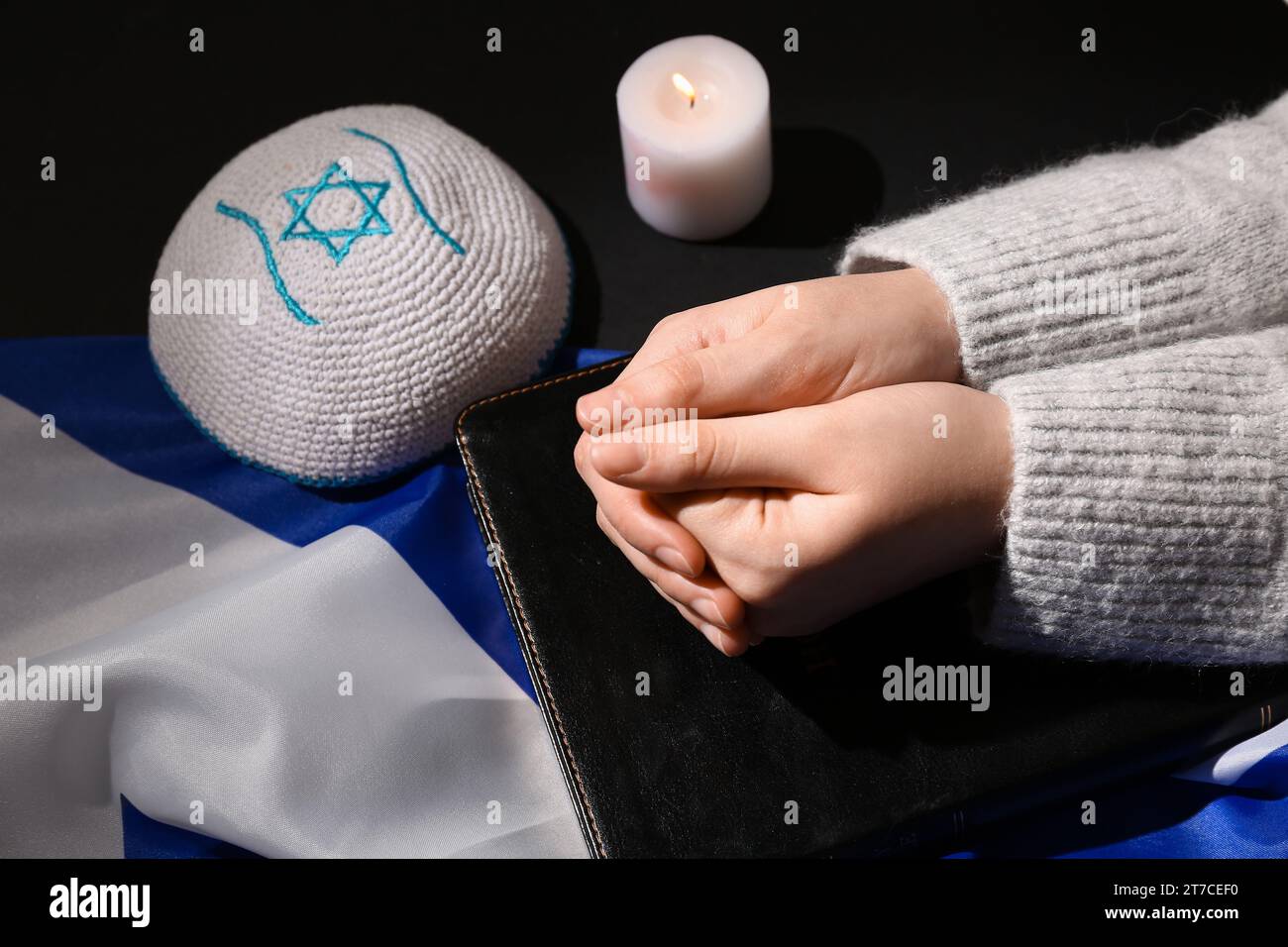 Praying woman with Torah, Jewish hat, burning candle and flag of Israel ...