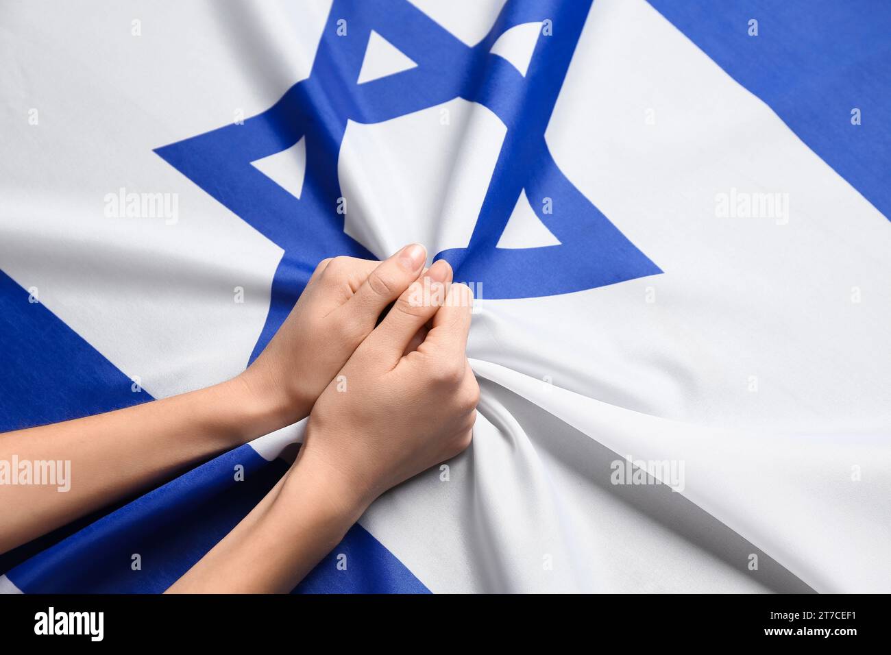 Female hands on flag of Israel Stock Photo - Alamy