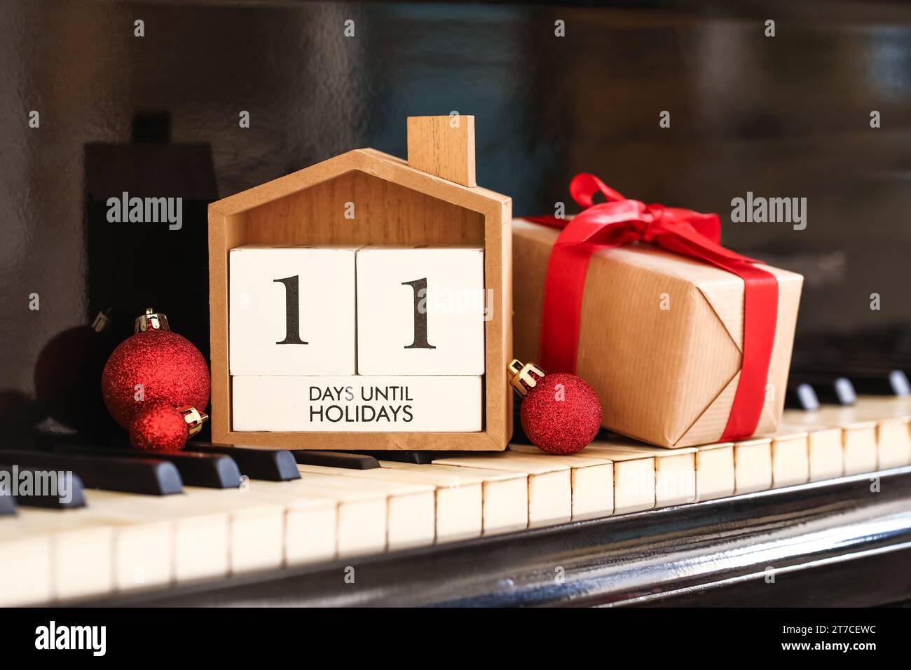 Calendar with text 11 DAYS UNTIL HOLIDAYS, Christmas gift and balls on ...