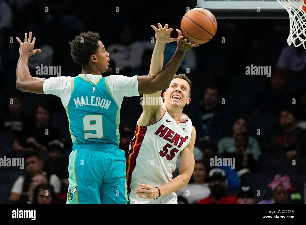 Miami Heat forward Duncan Robinson, right, fouls Charlotte Hornets ...