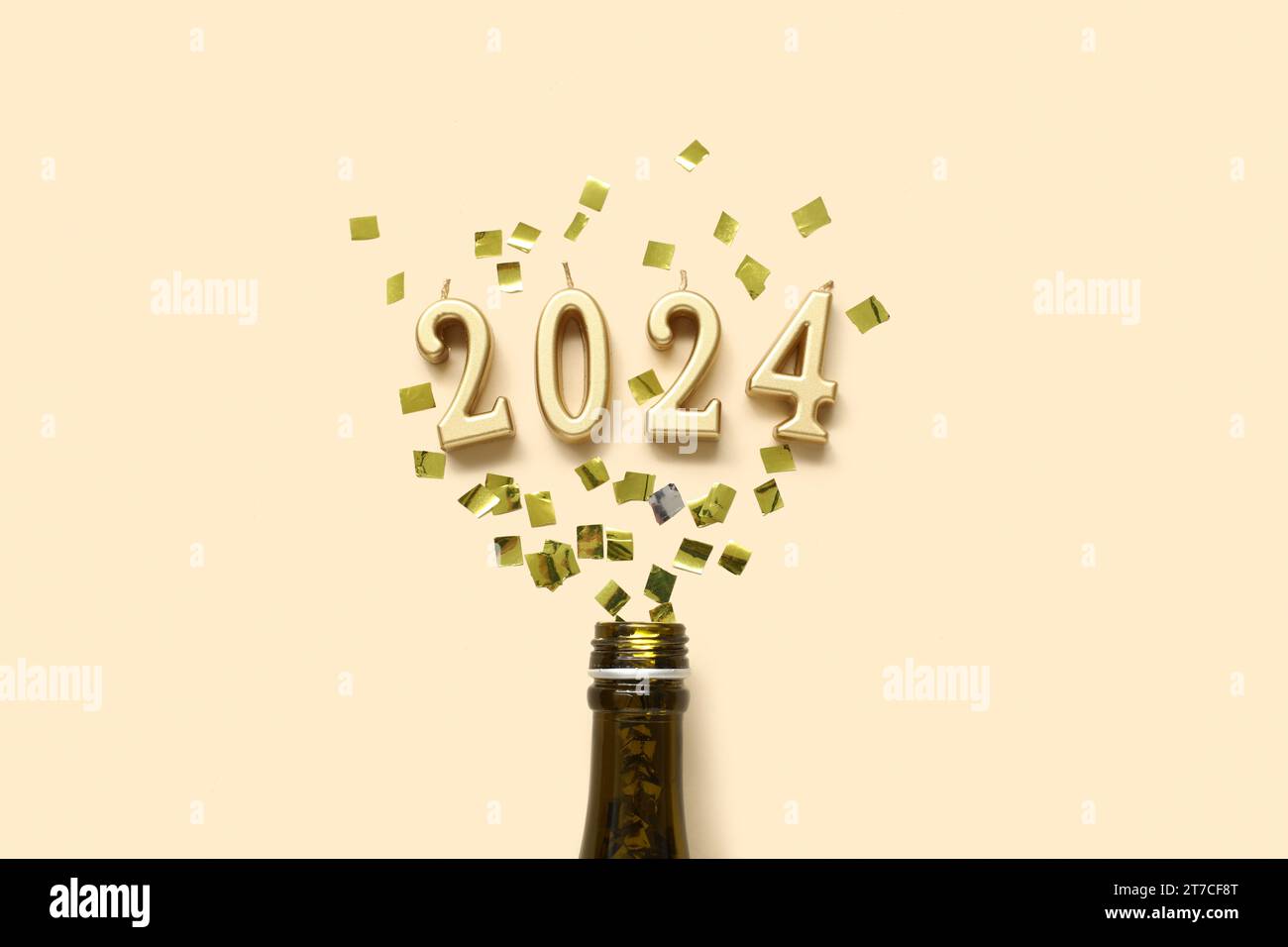 Composition with candles in shape of figure 2024, confetti and bottle ...