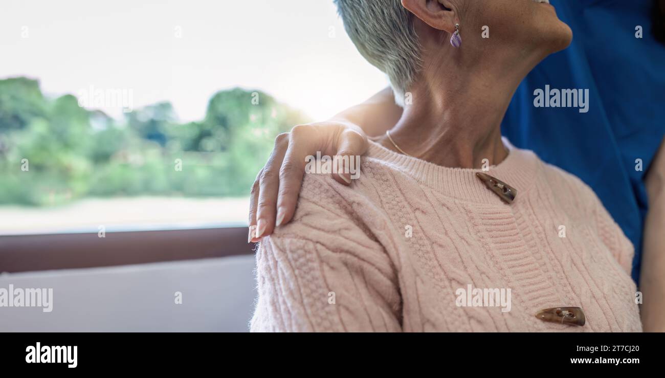 Caregiver or nurse put hands around shoulder of elderly patient for ...