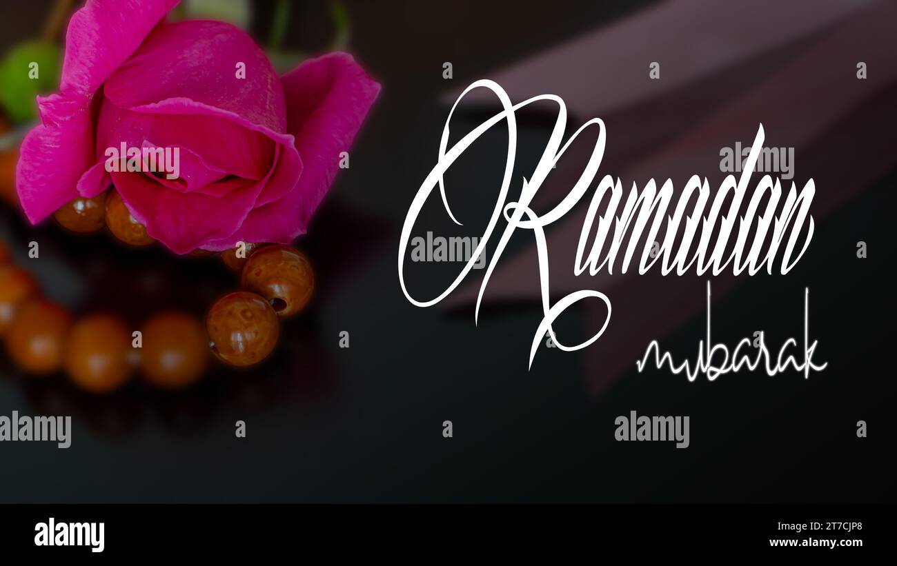 Ramazan Mubarak or Ramadan Kareem. Pink rose and rosary on a black ...