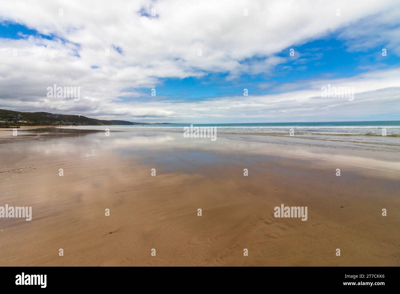 Sky is reflected in the shallow waves on Lorne Beach, Great Ocean Road ...