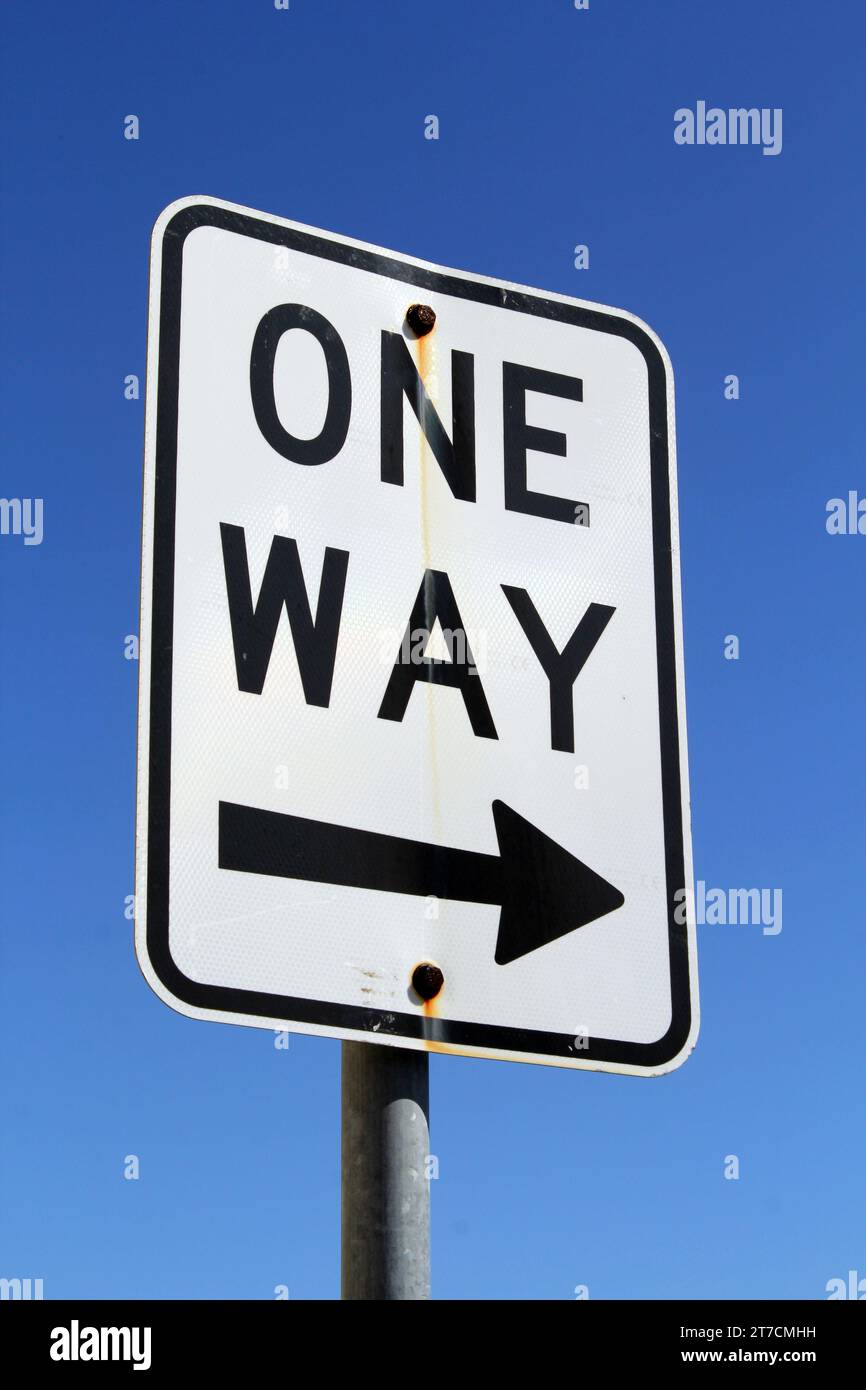 One way street road sign against a blue sky background Stock Photo - Alamy