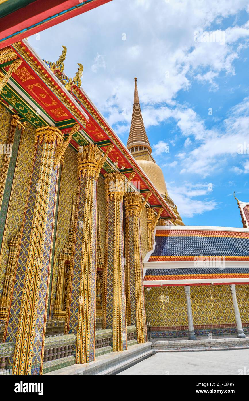 View of a row of fancy gold columns and the main stupa. At Wat ...