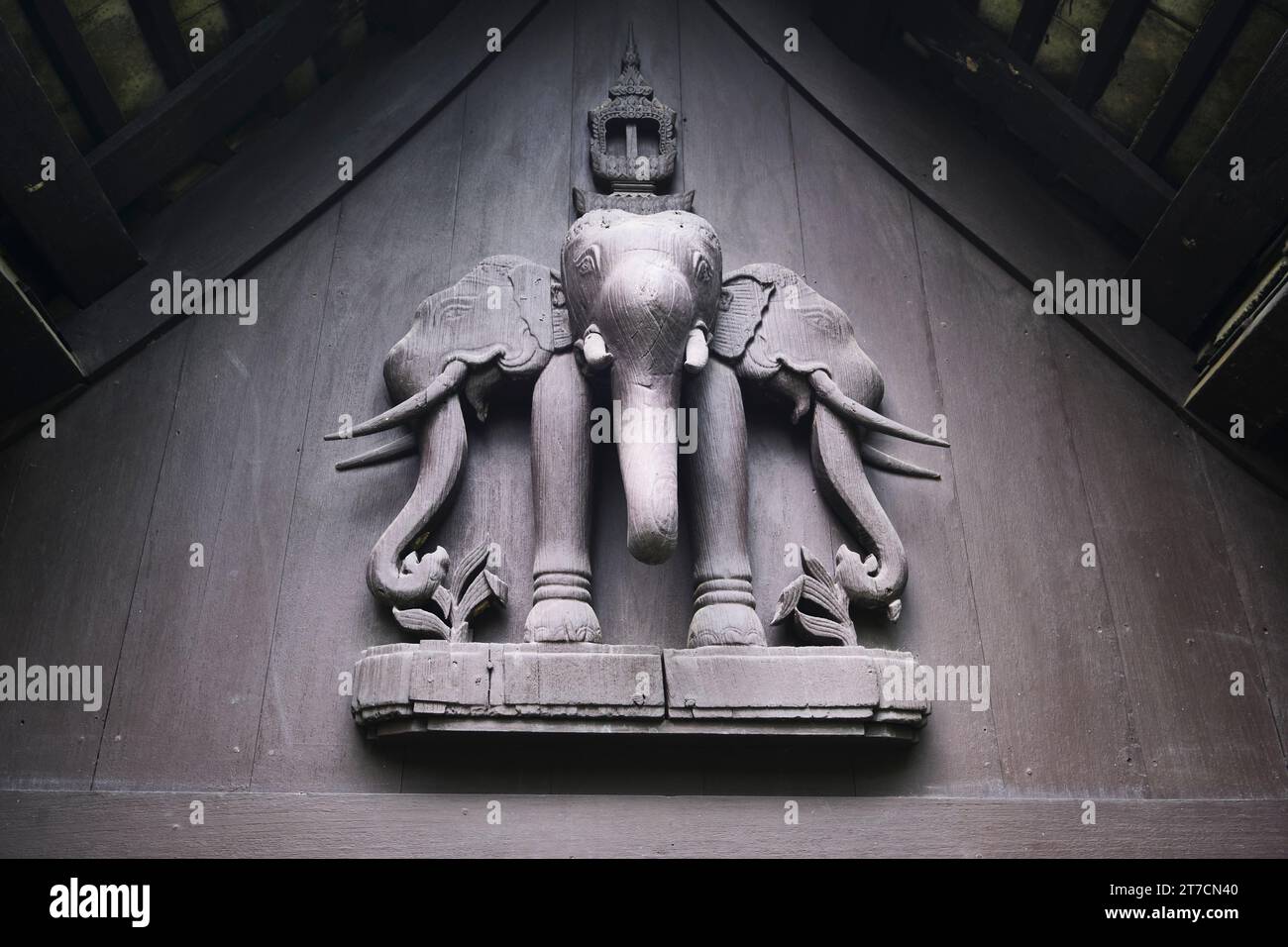 A grey wood carving of the mystical three headed elephant, decorating a ...