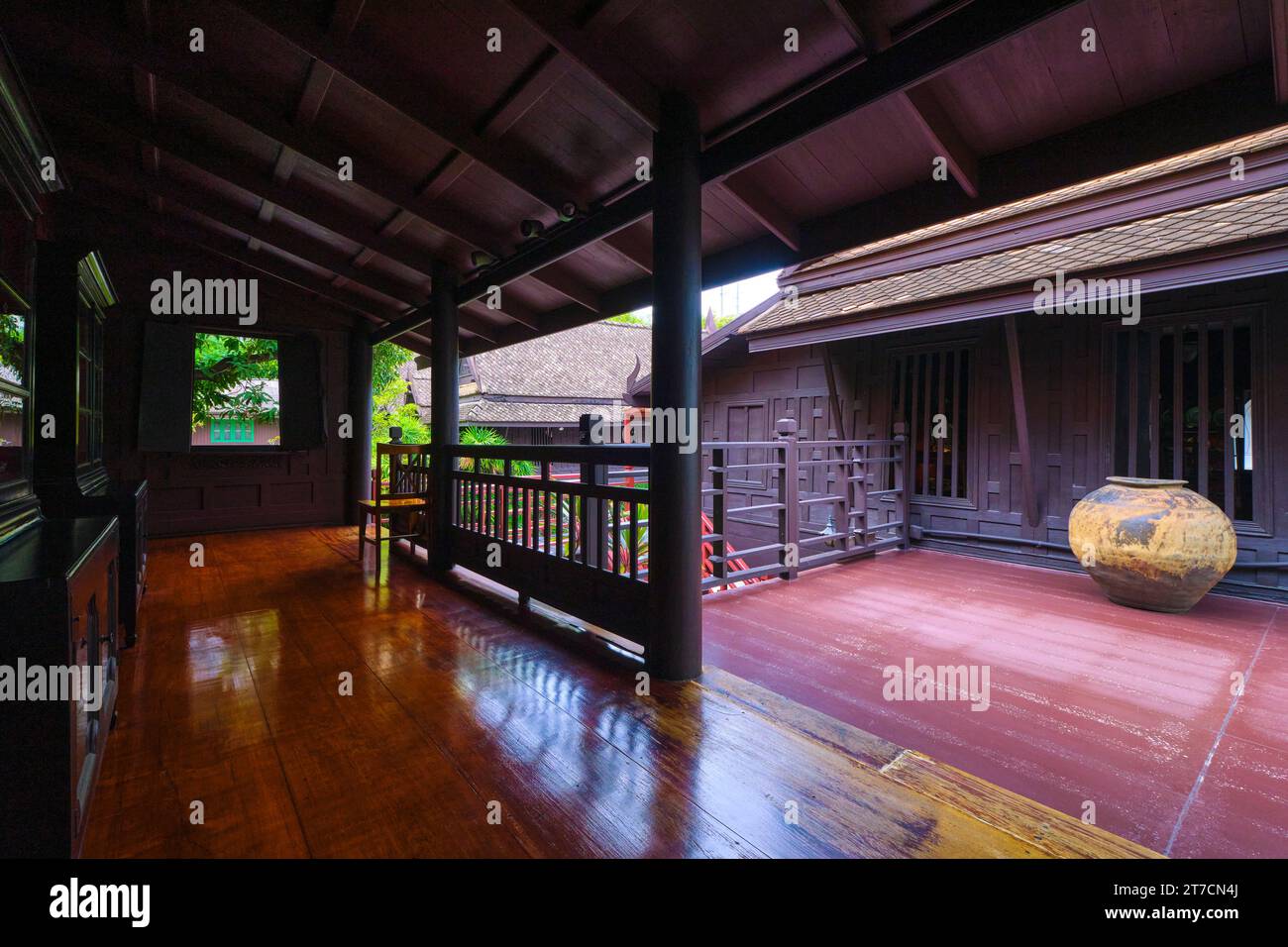 View of a wide, wood veranda with large overhang to protect from sun ...