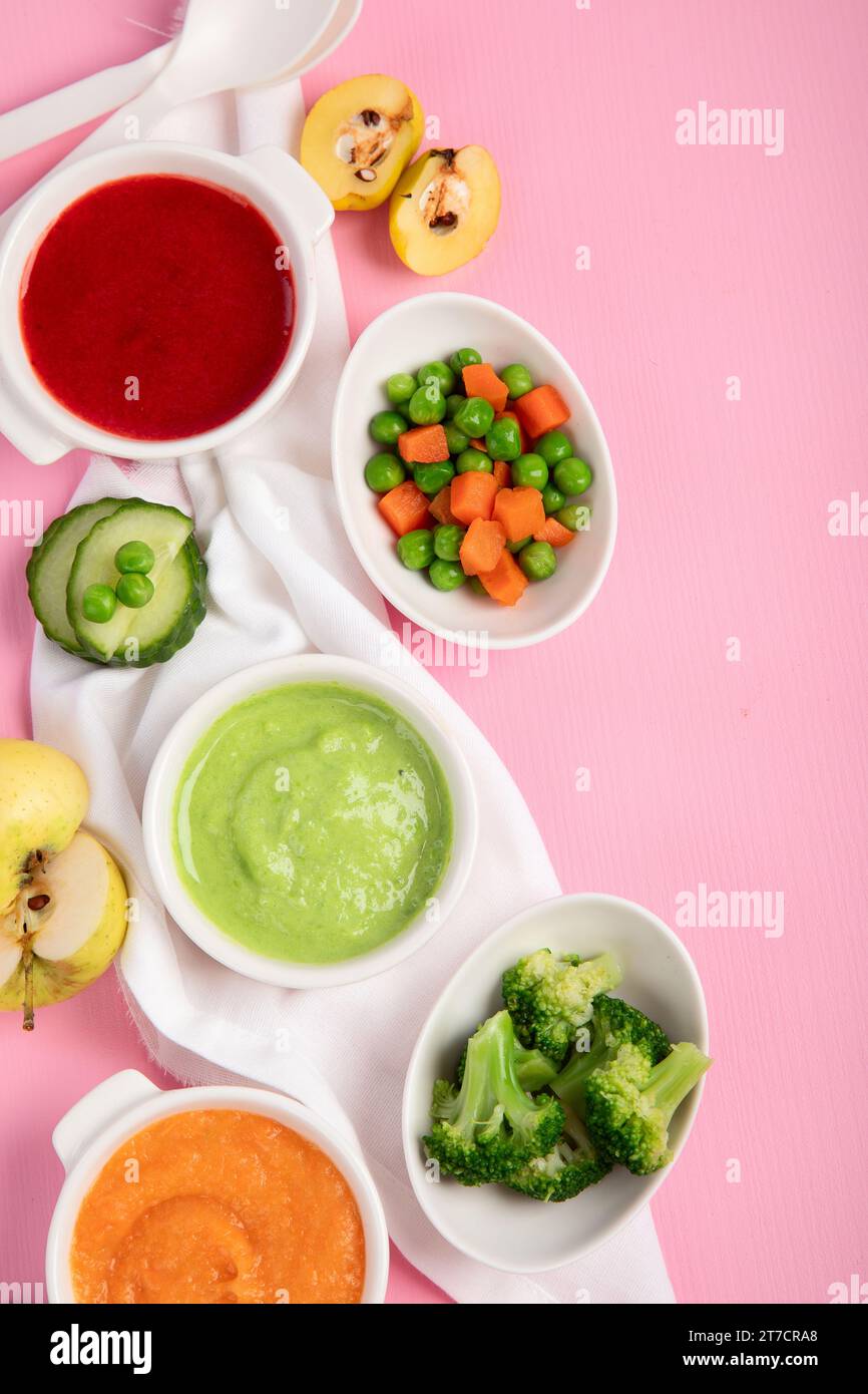 Vegetable and fruit baby puree in white bowls with ingredients on a ...