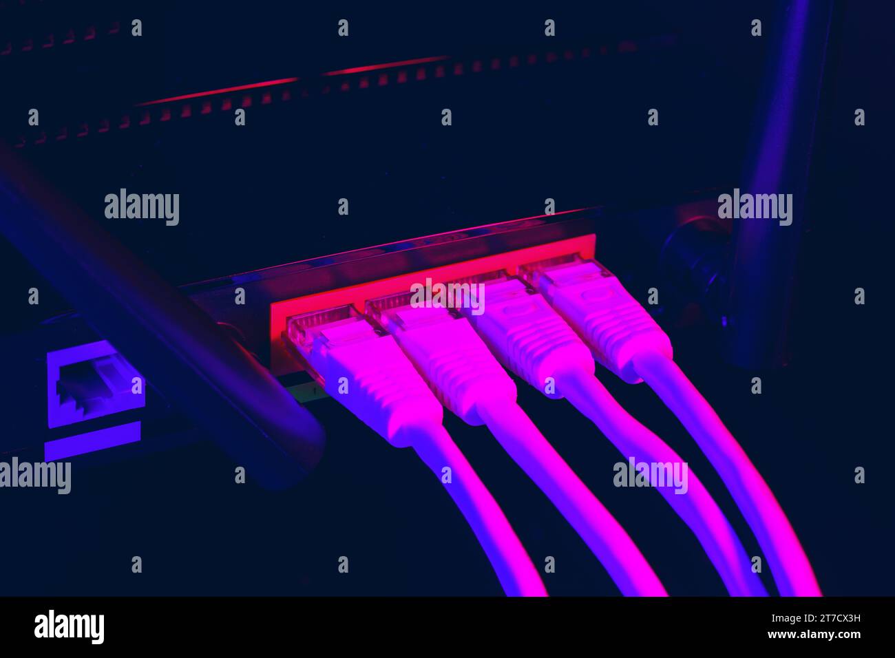 Cables plugged in a Wi-Fi router on dark background Stock Photo - Alamy