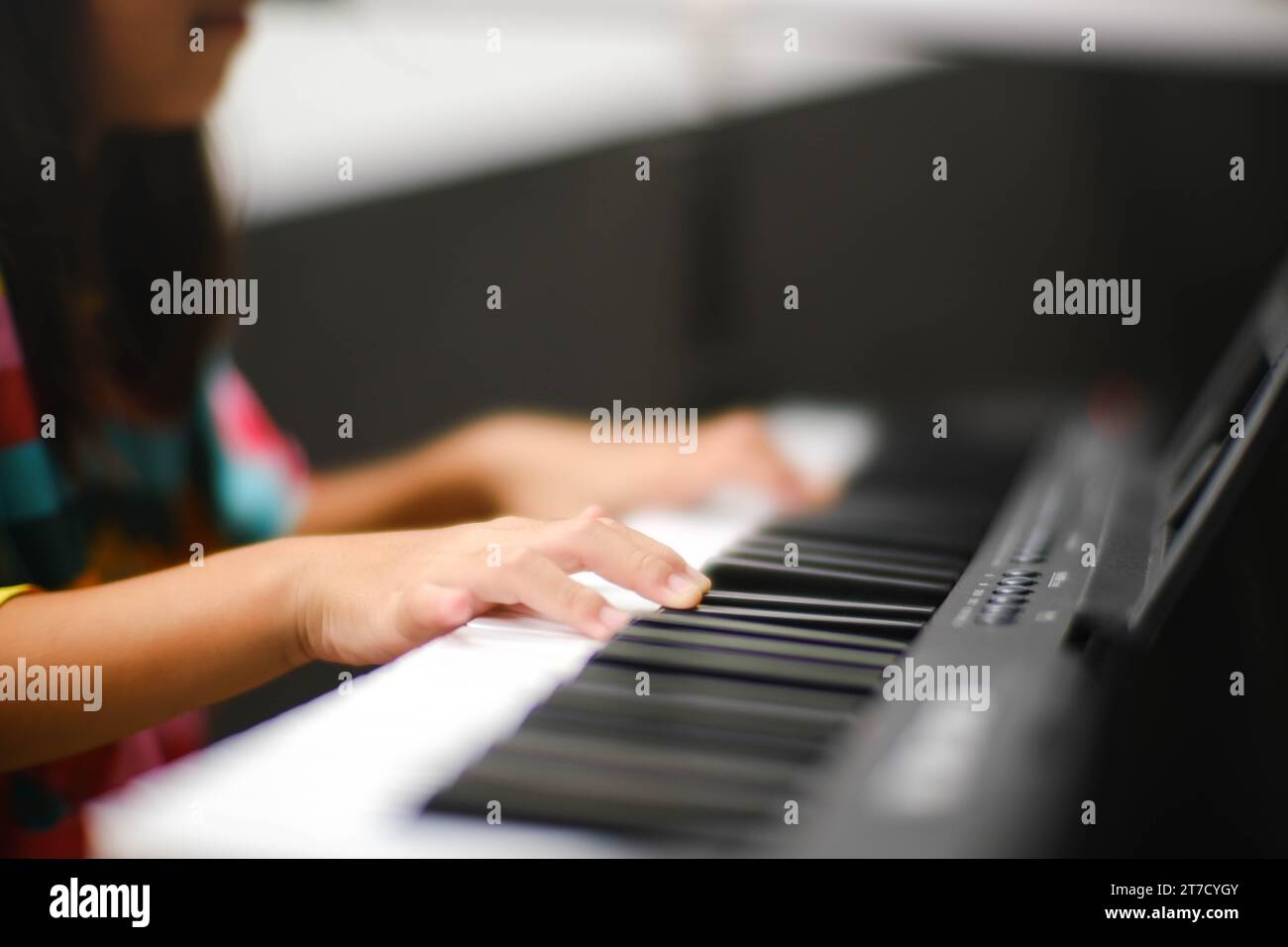 Close-up of a little student's hand playing the piano. Happy young ...