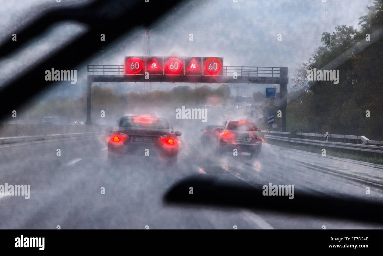 29 October 2023, Hesse, Ober-Mörlen: Cars driving at dusk in the rain ...