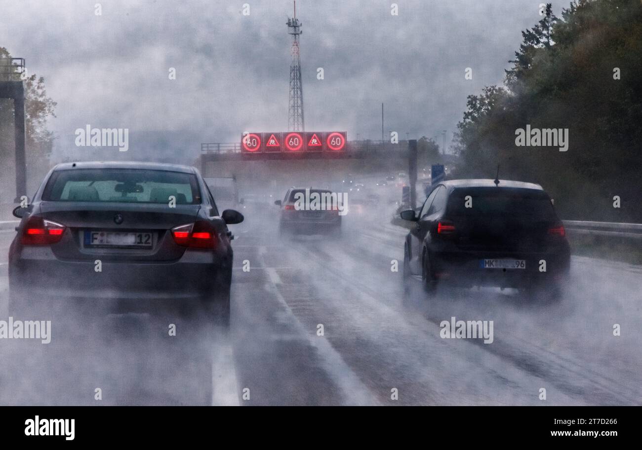 29 October 2023, Hesse, Ober-Mörlen: Cars driving at dusk in the rain ...
