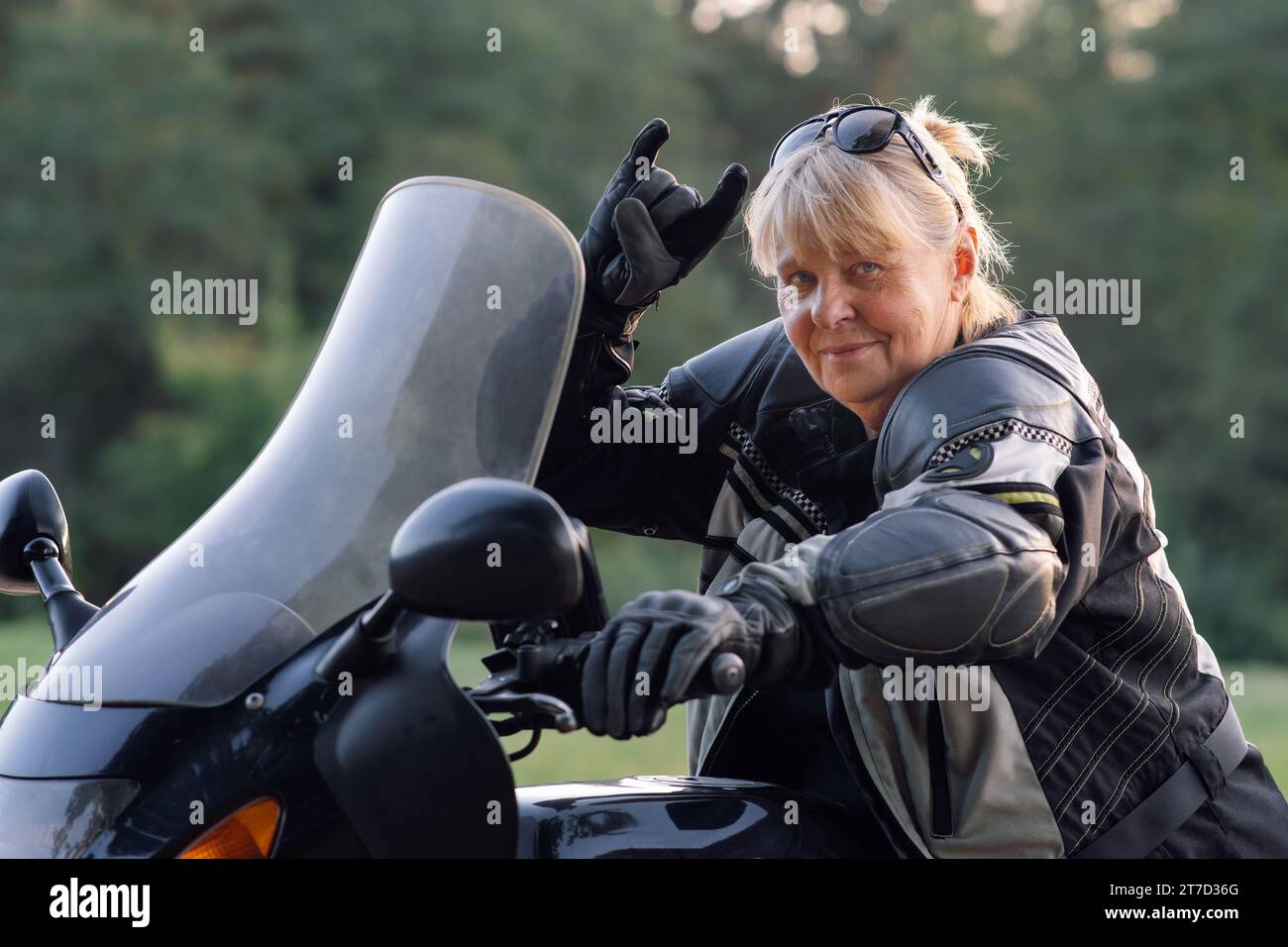 Super mom, blonde biker granny gestures ok while sitting on her ...