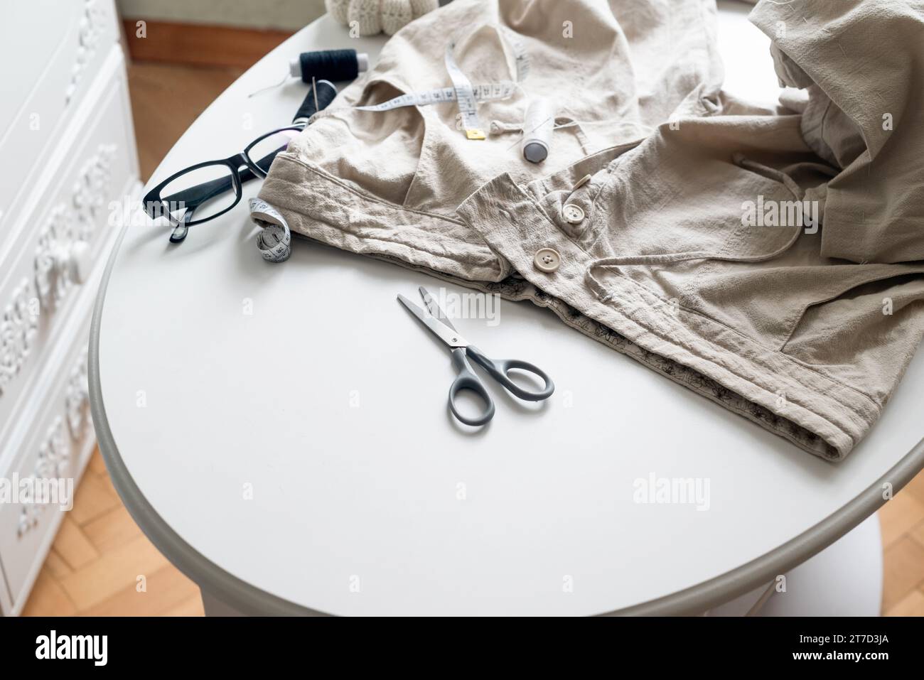 linen trousers with tools to repair old clothes. Sewing and home ...