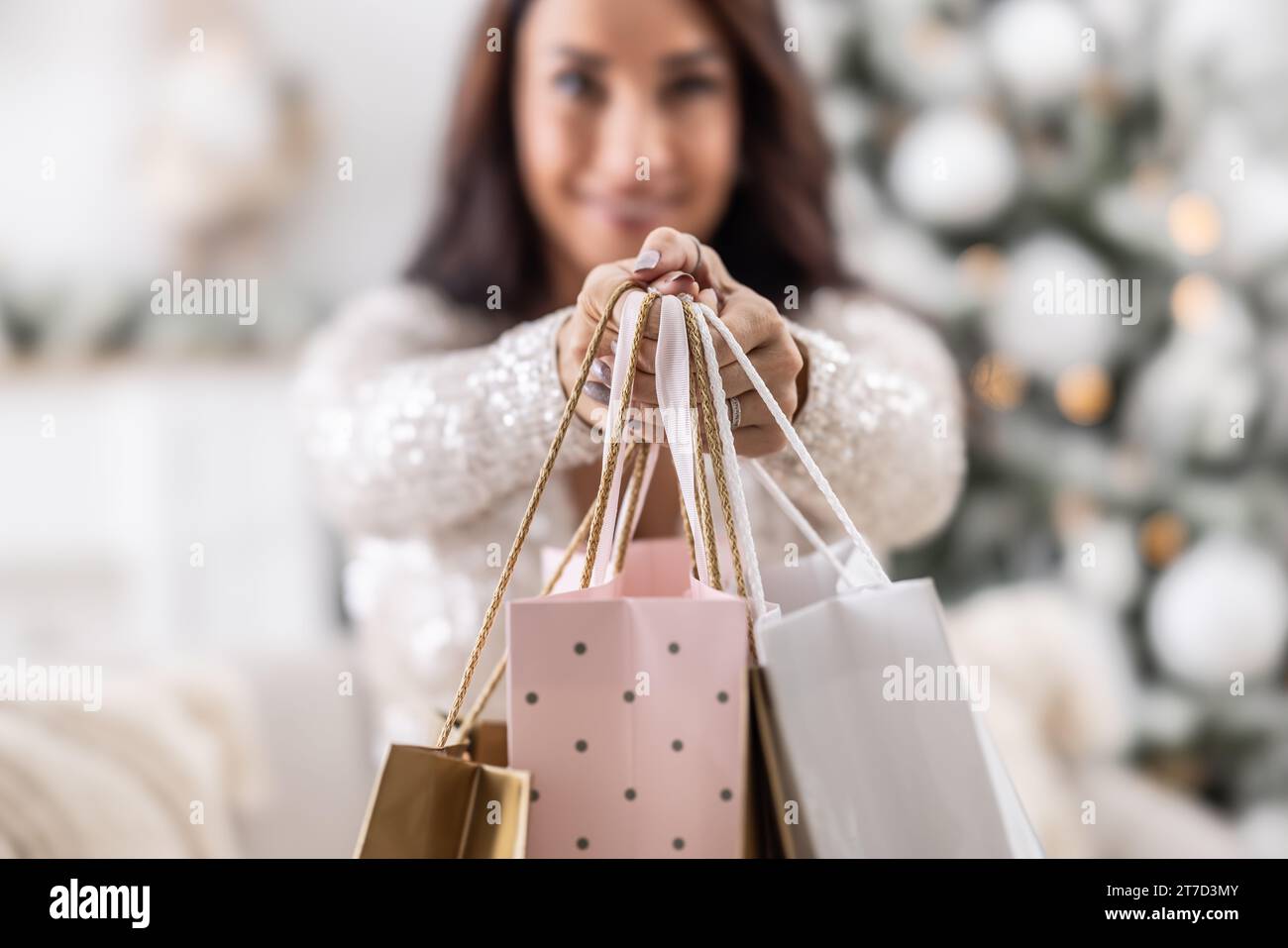 Christmas shopping done as woman hands over several paper bags with ...
