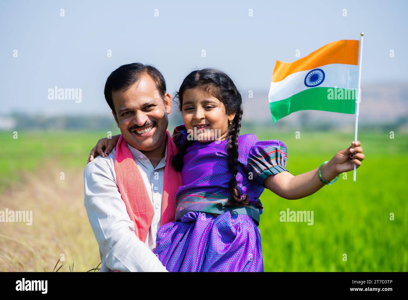 Happy Indian village father carrying daughter with indian flag by ...