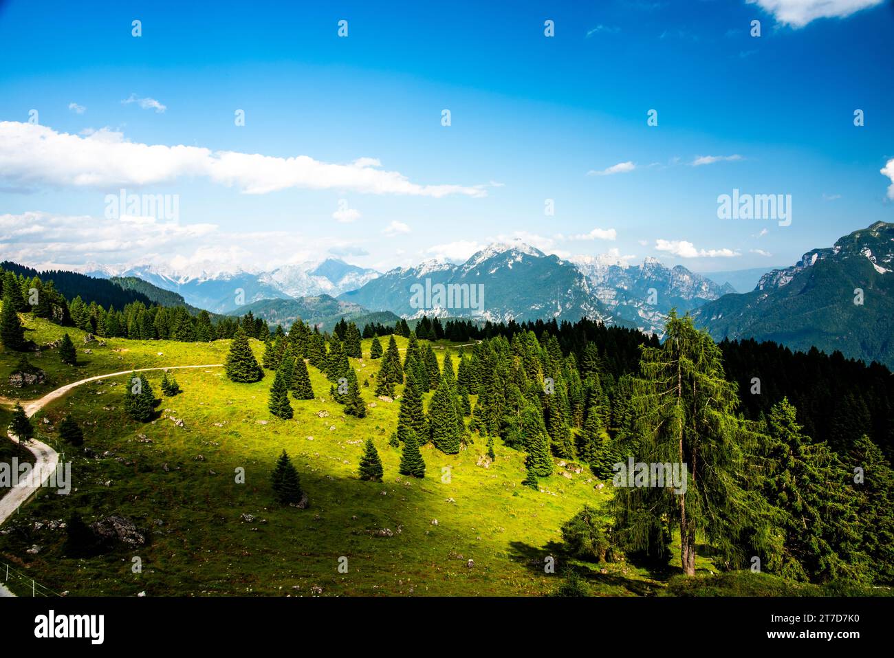 Dolomite mountains and Alps peaks with green meadows and rock spiers ...