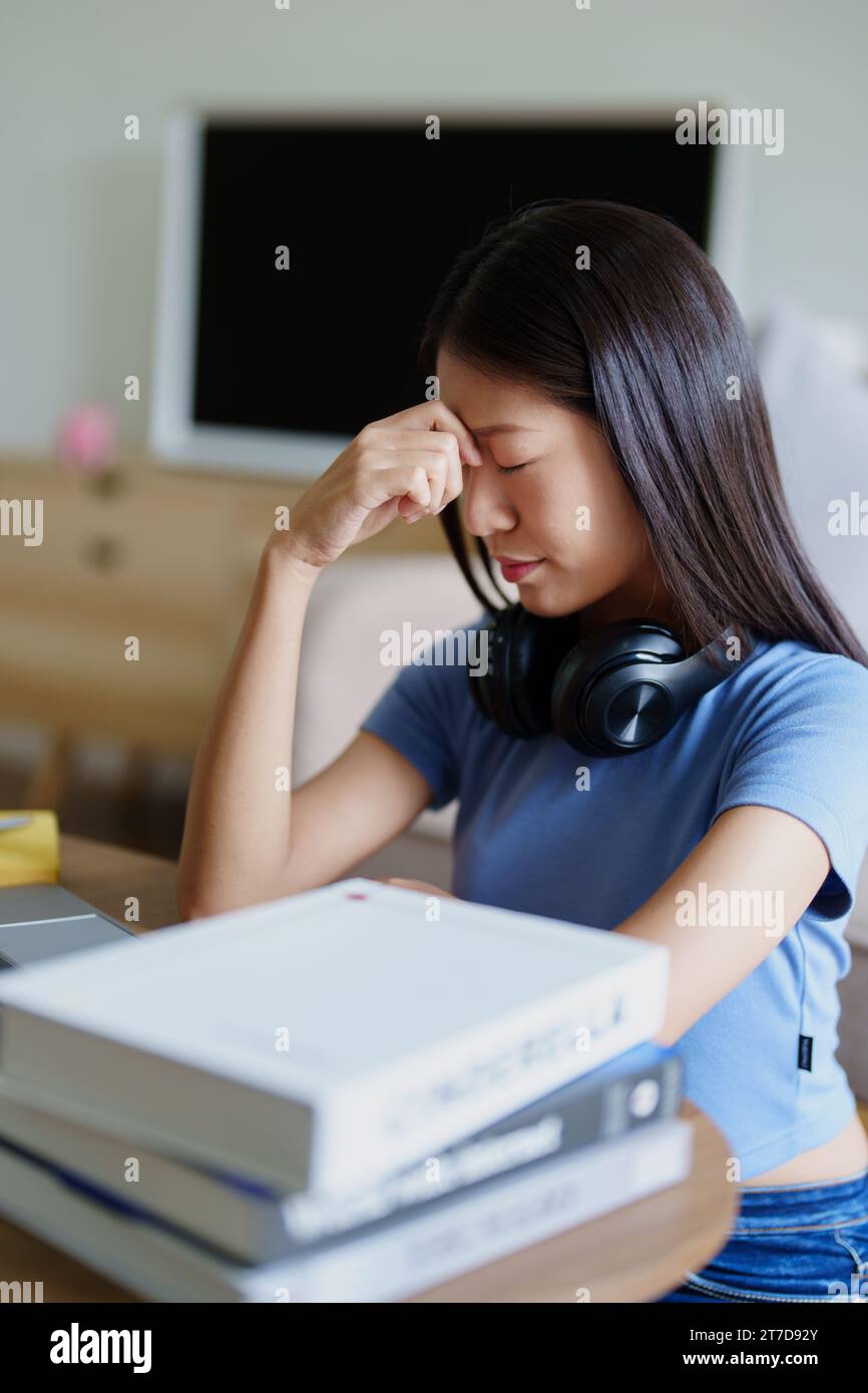Studying online, beautiful Asian female student show symptoms burnout ...