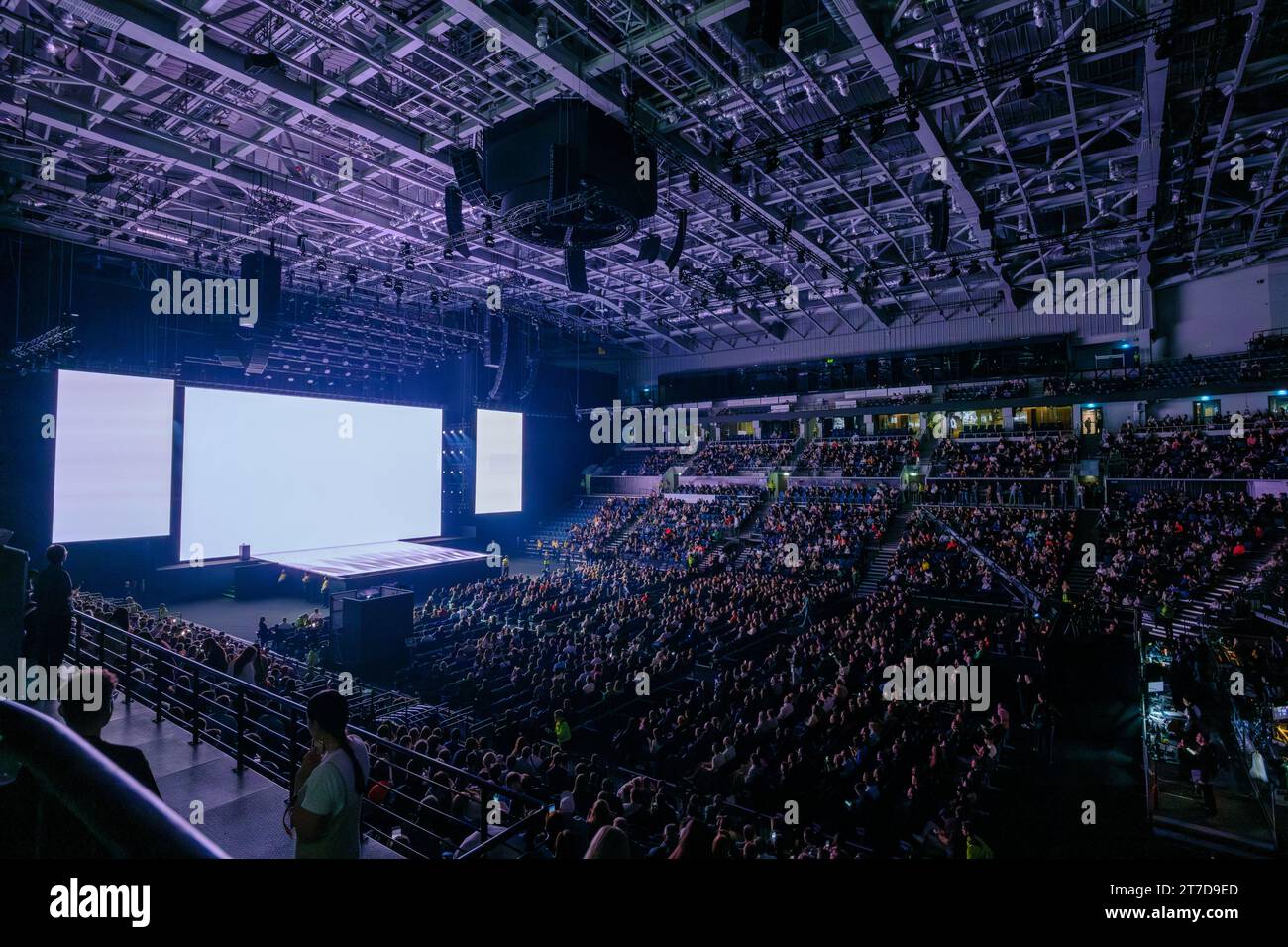 Aerial drone view of business crowd in huge stadium with blank ...