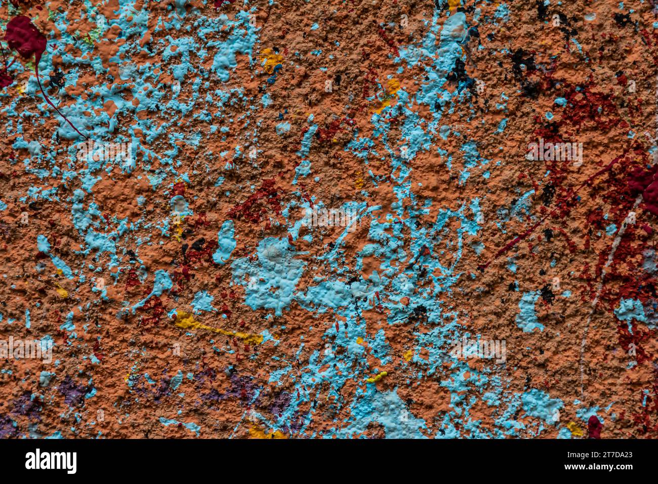 White plastered wall splattered with red paint. Paint splashes on the ...