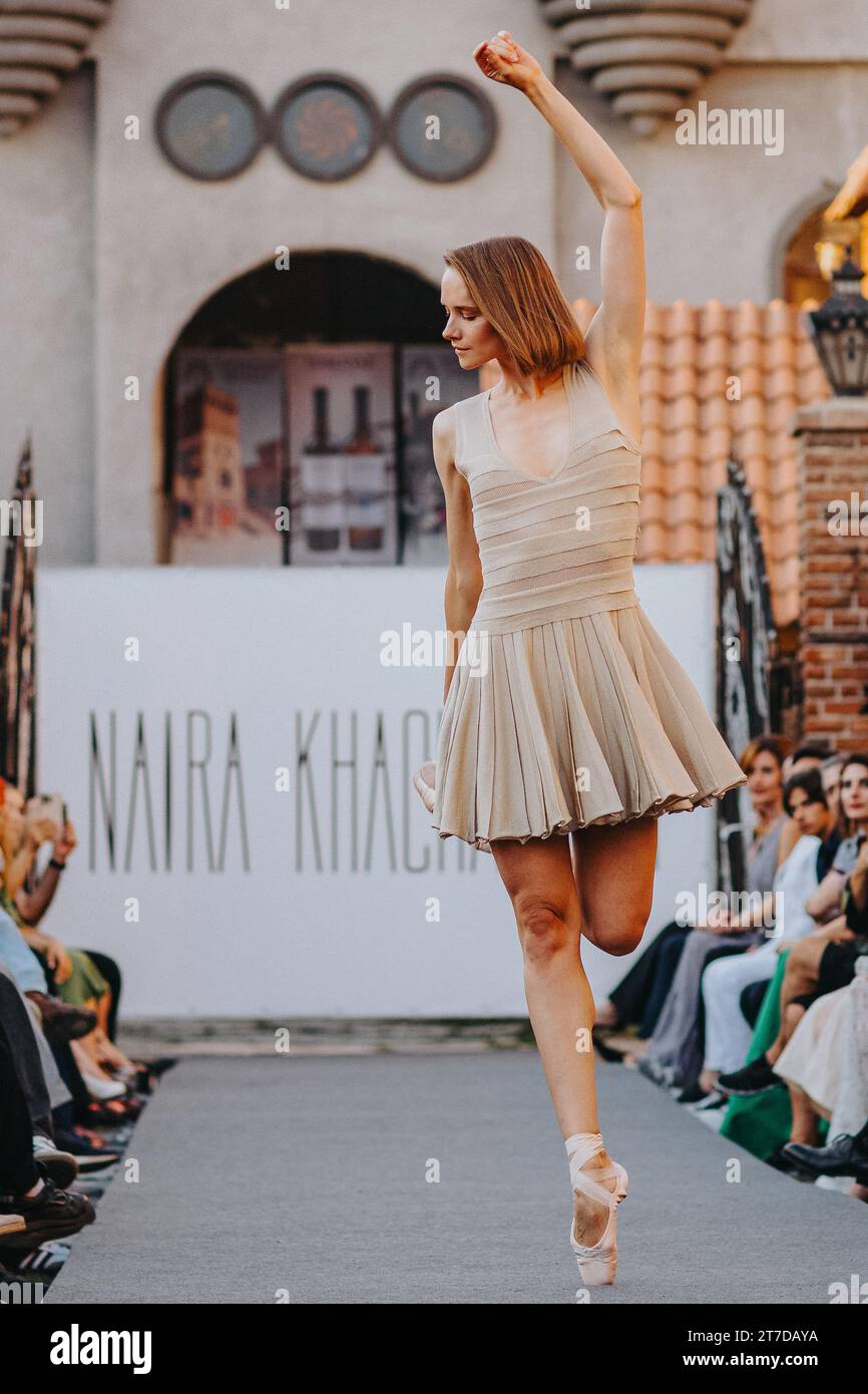 A graceful ballerina pirouetting on a brightly lit fashion runway Stock ...