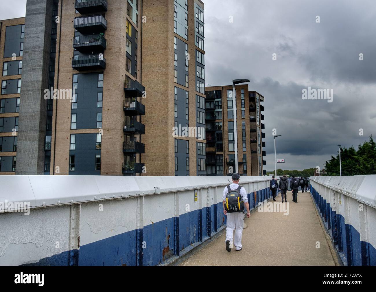 People walking across the bridge over the lines at Hornsey train ...