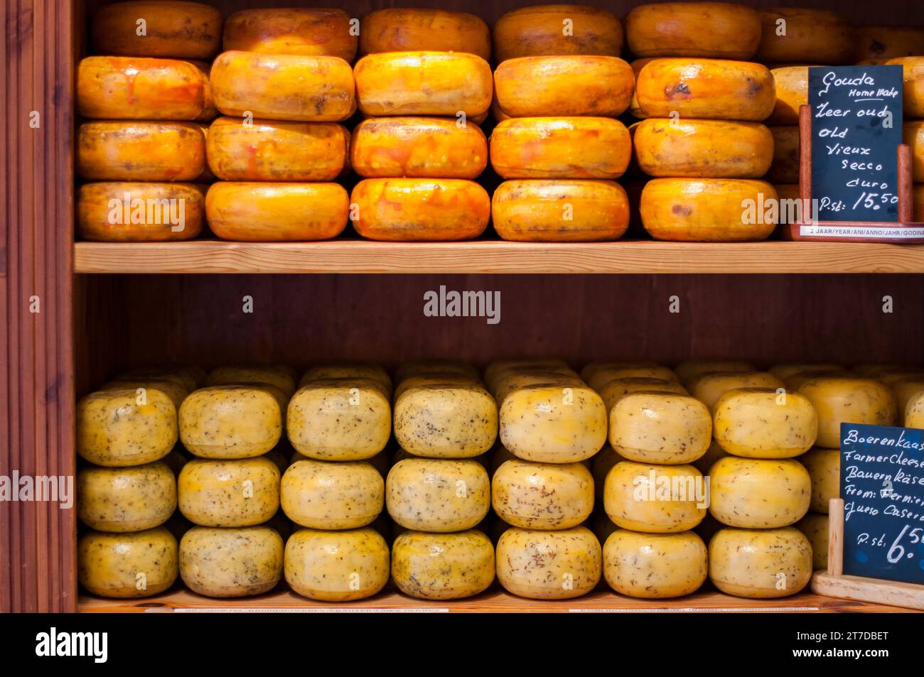 Cheese wheels in a market in Amsterdam, Netherlands. The signs read, in ...