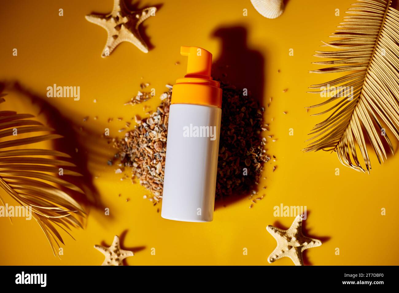 Top view, flat lay Sunscreen tube mockup with shells, sand yellow ...