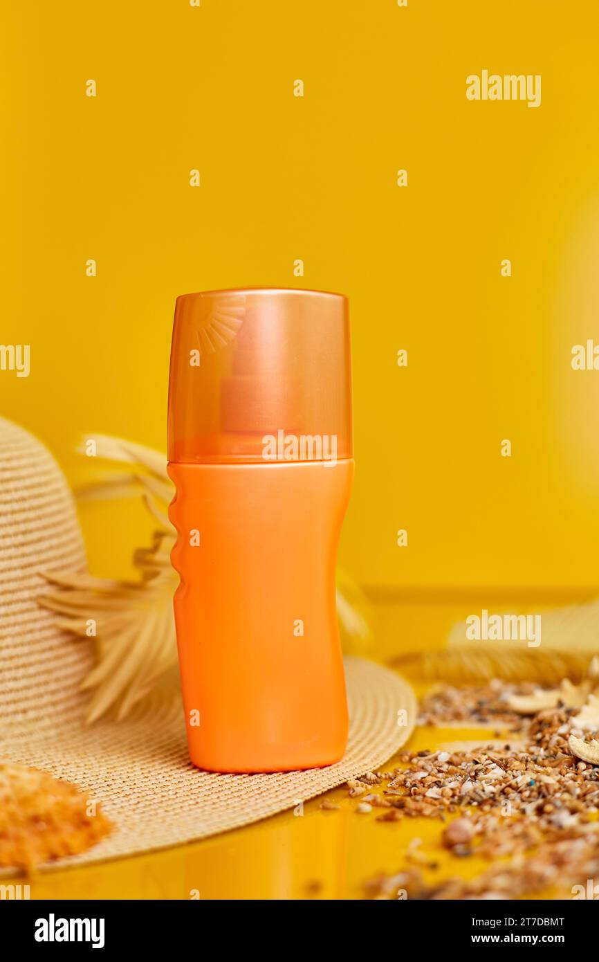 Sunscreen tube mockup with shells, sand yellow background, summer ...