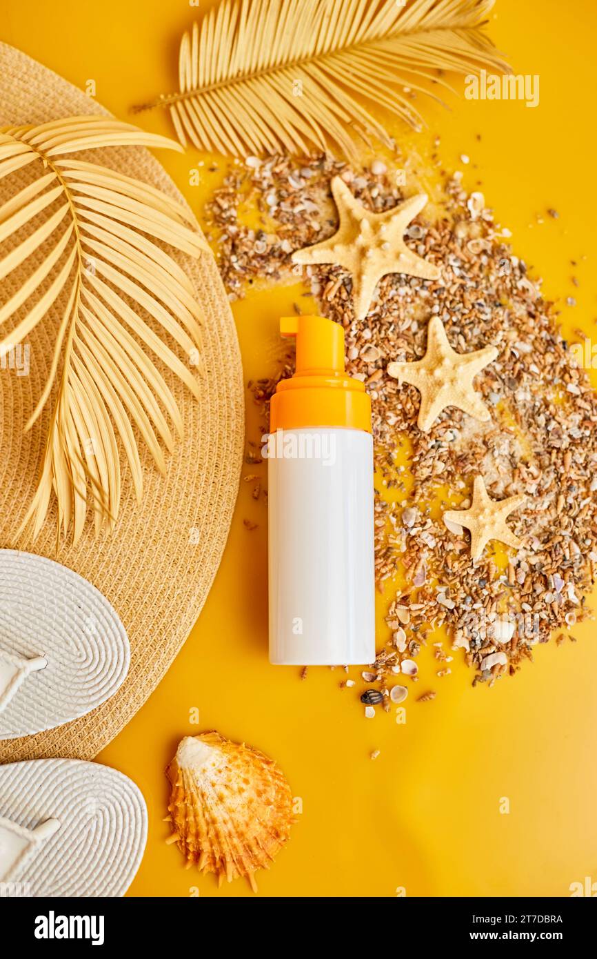 Flat lay, top view Sunscreen tube mockup with shells, sand yellow ...