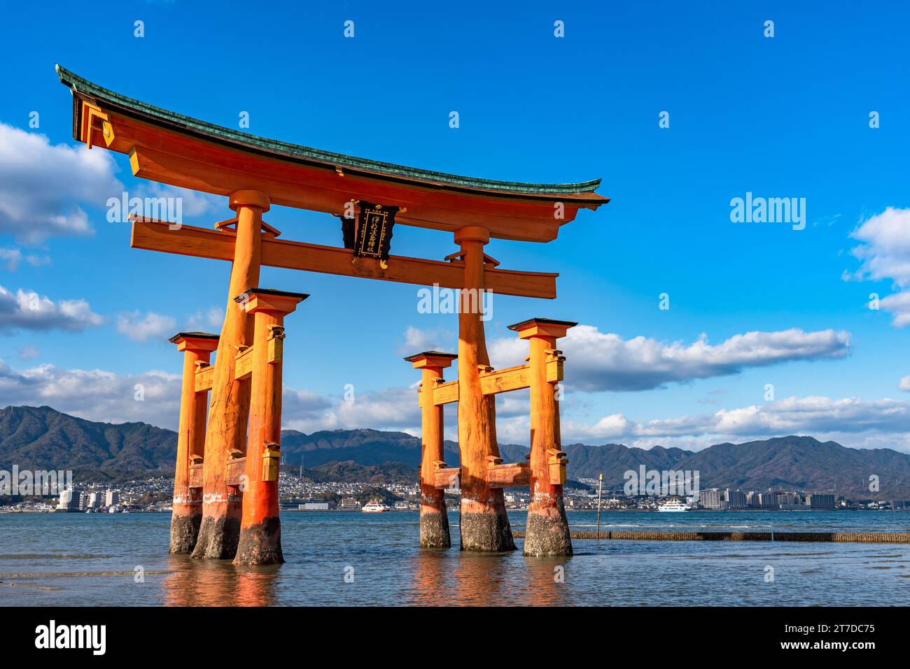 Floating orange red giant Grand O-Torii gate stands in Miyajima island ...