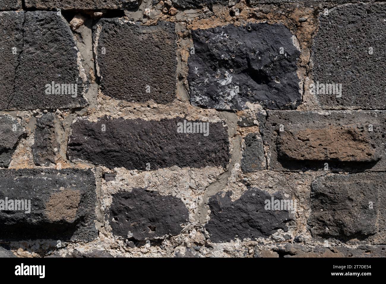 A detail of a section of basalt rock wall forming part of the restored ...