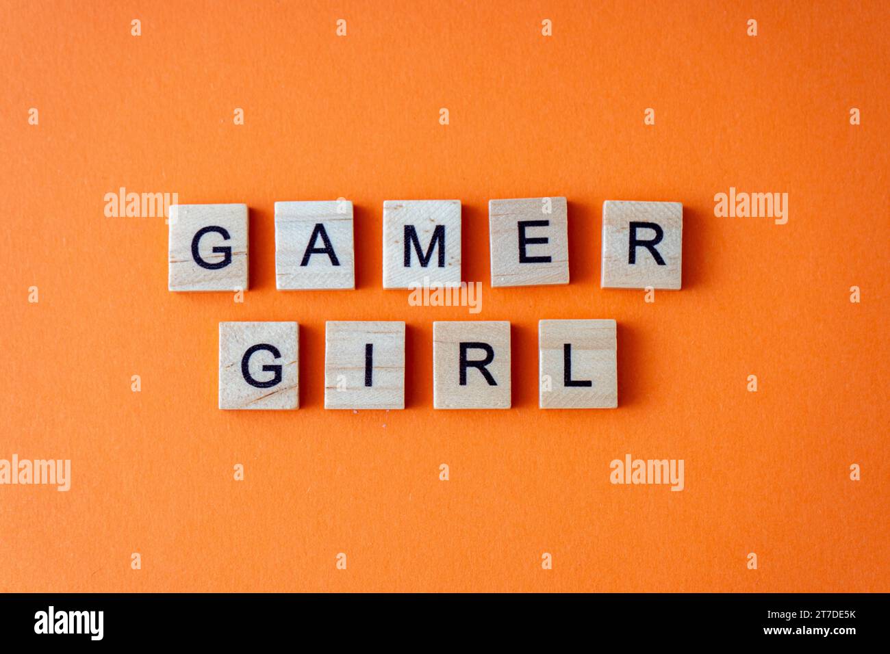 Word gamer girl. The phrase is laid out in wooden letters top view ...
