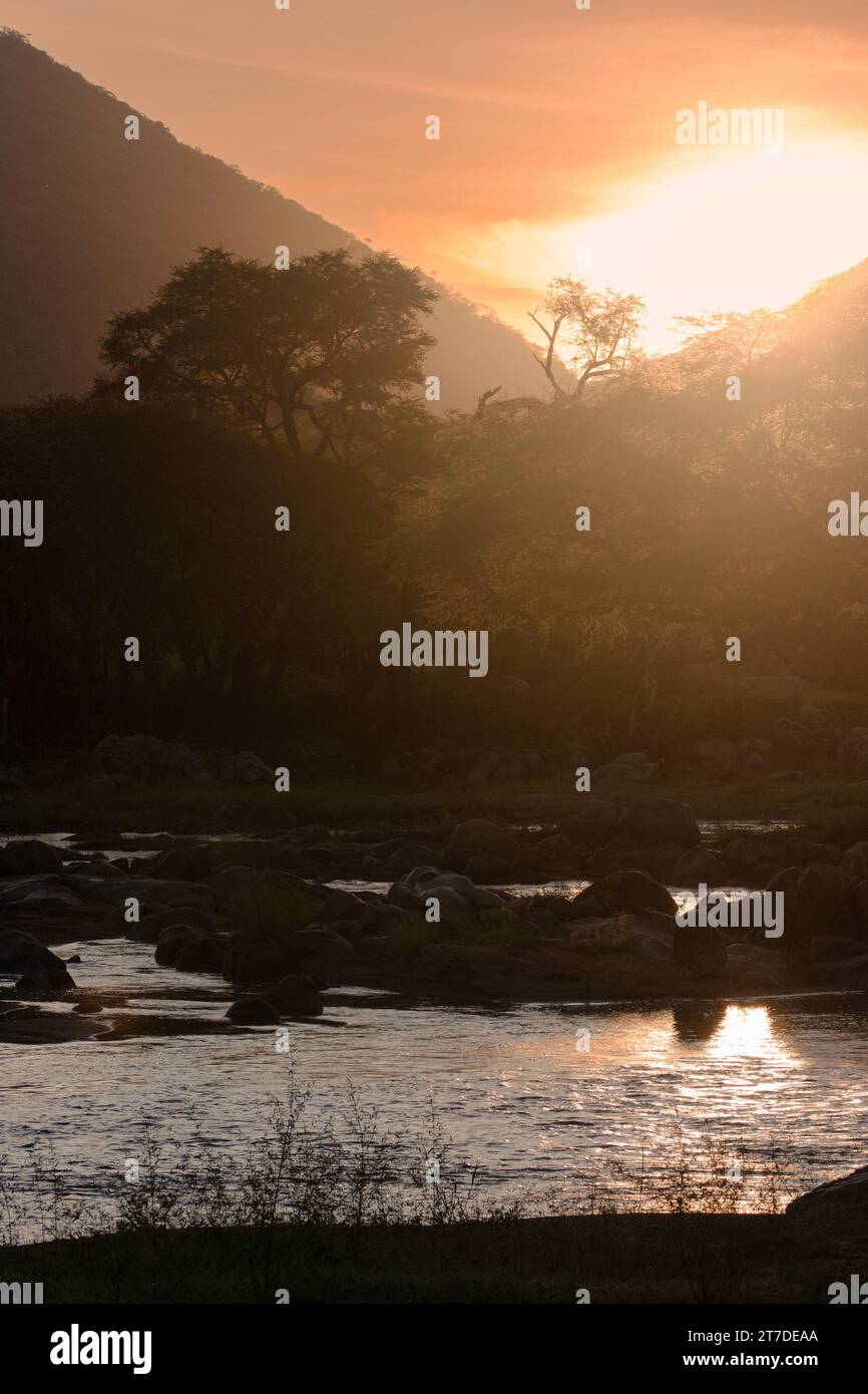 A tranquil dawn breaks through the Chiriwindi hills on the banks of the ...