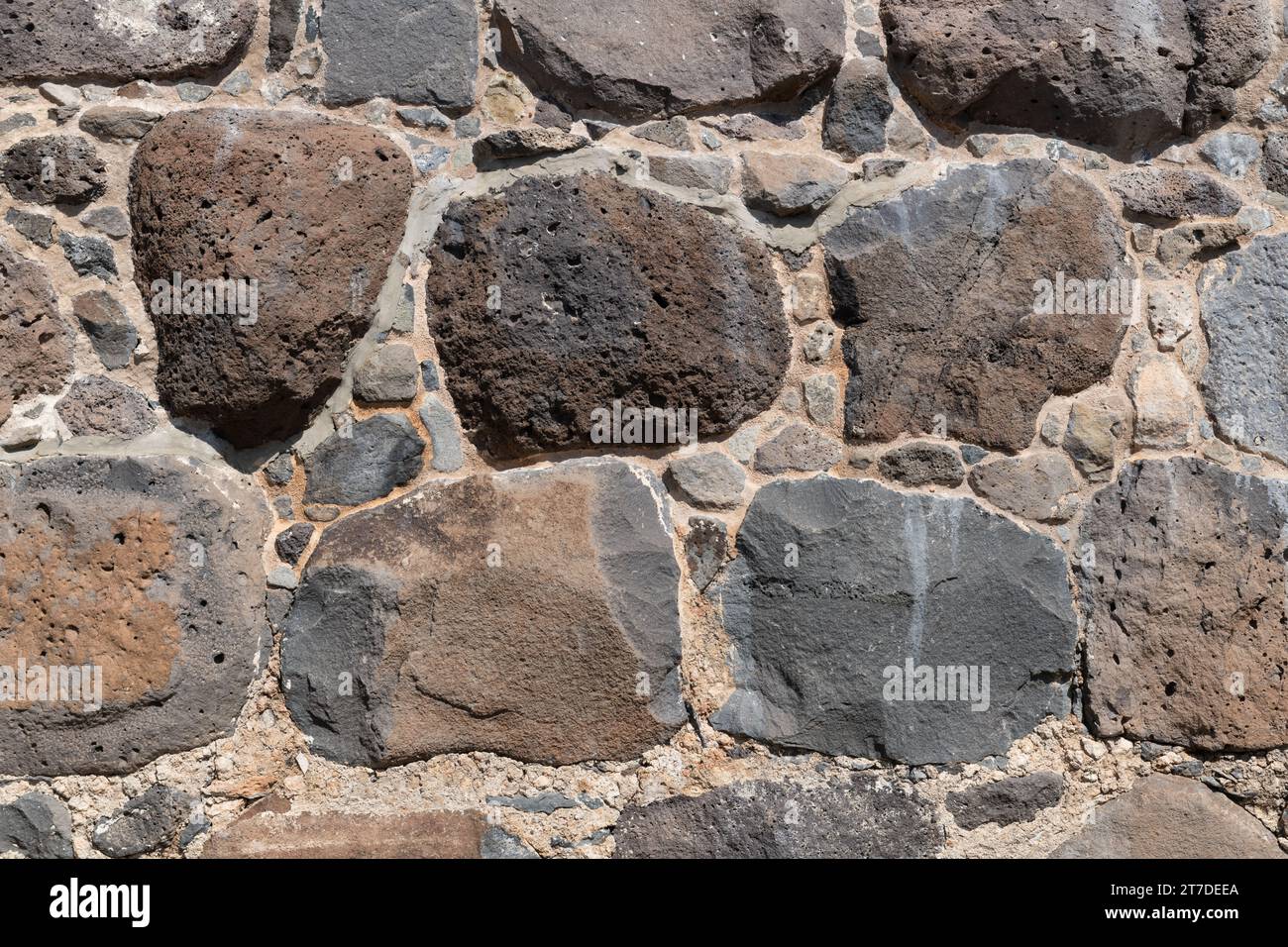 A detail of a section of basalt rock wall forming part of the restored ...