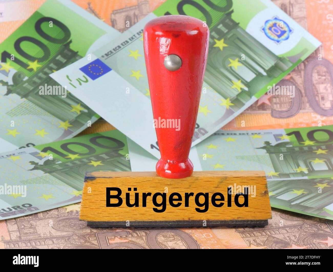 Stempel mit Aufdruck Buergergeld mit Geldscheinen und Euromuenzen ...