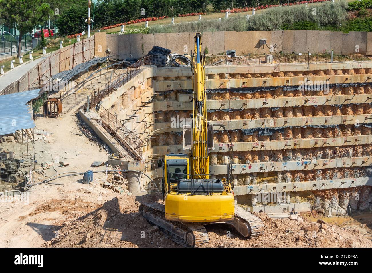 Pit of a metro station with piles ground, working orange excavator dig ...