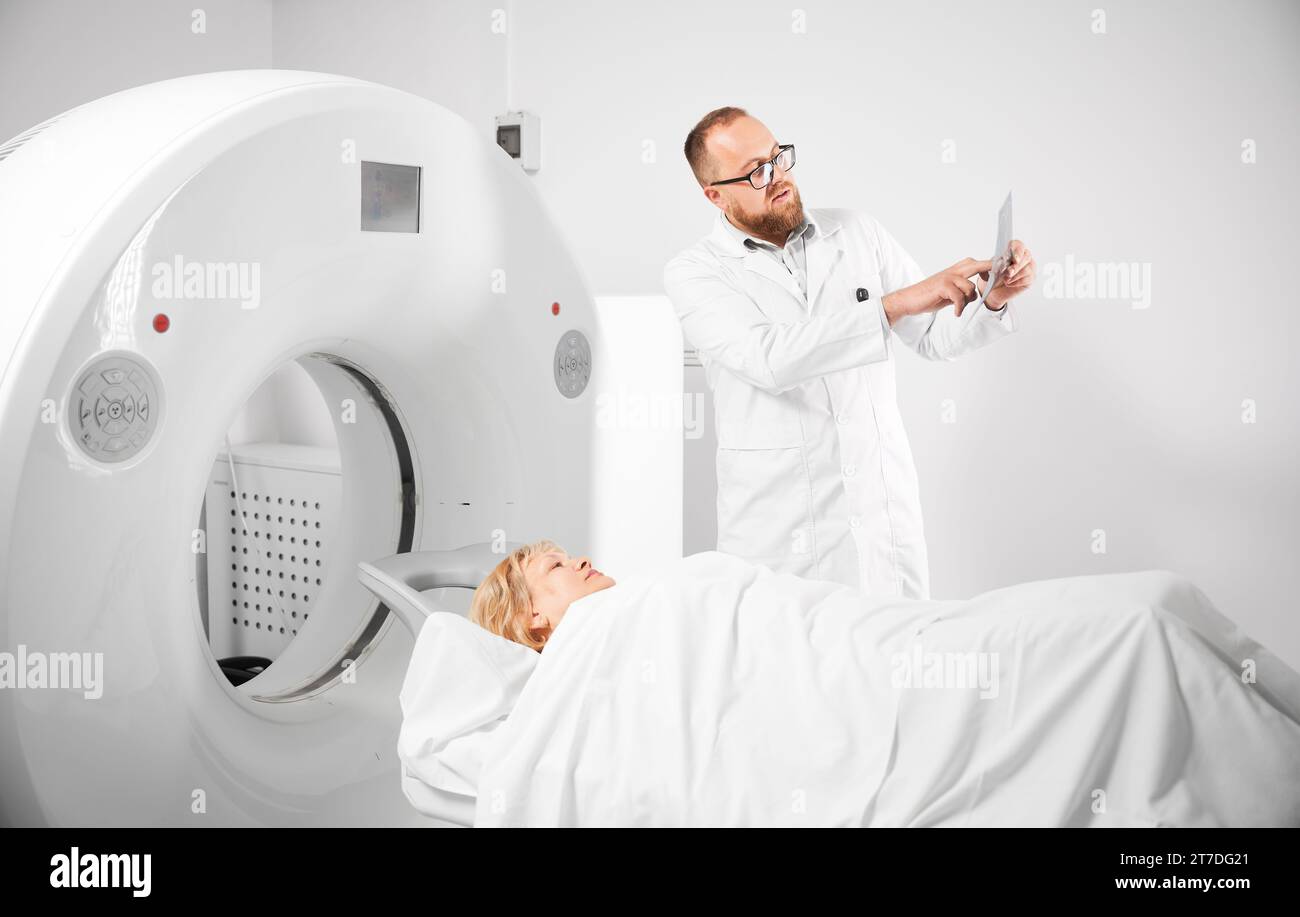 Medical computed tomography or MRI scanner. Doctor holding and ...