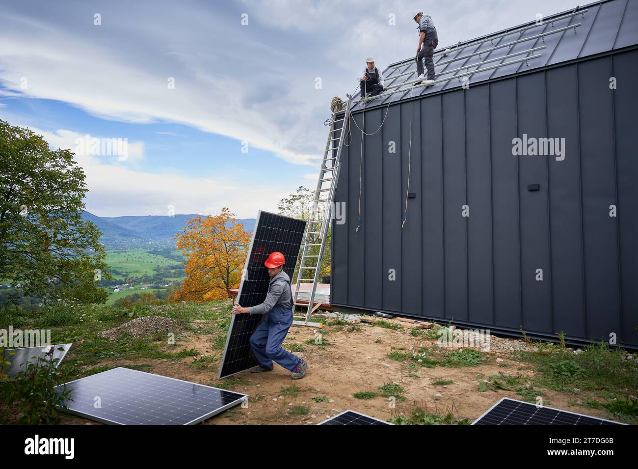 Technician building solar panel system on roof of house. Man worker in ...