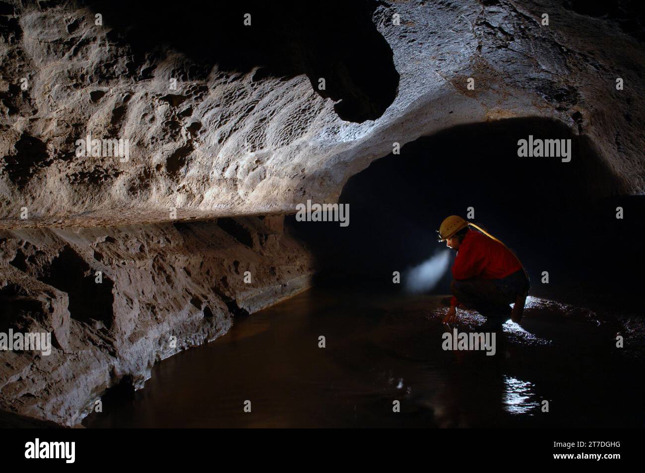 Cave explorer, spelunker, archeologist stuydying underground passage in ...