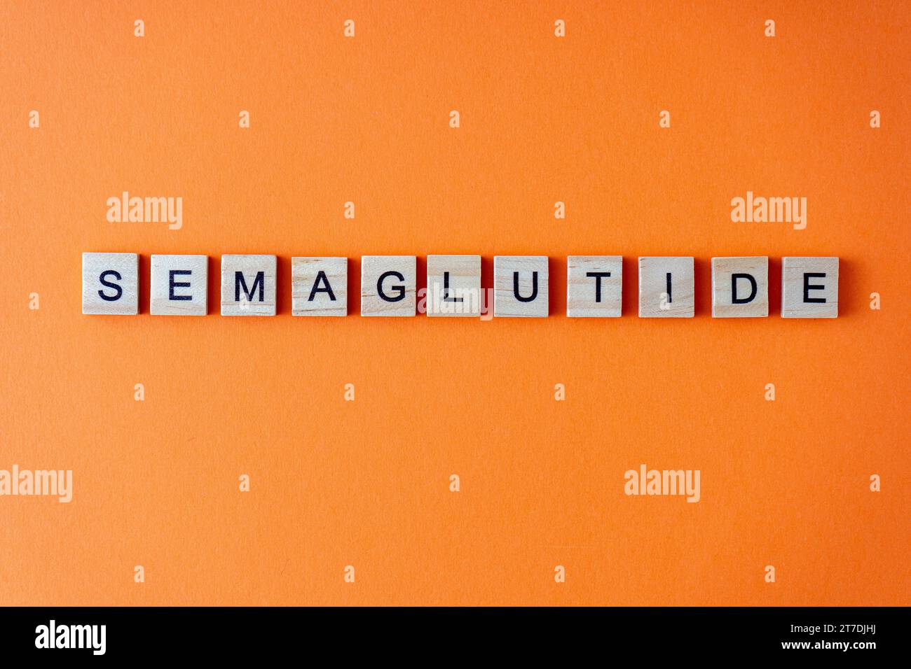 Word semaglutide. The phrase is laid out in wooden letters top view ...