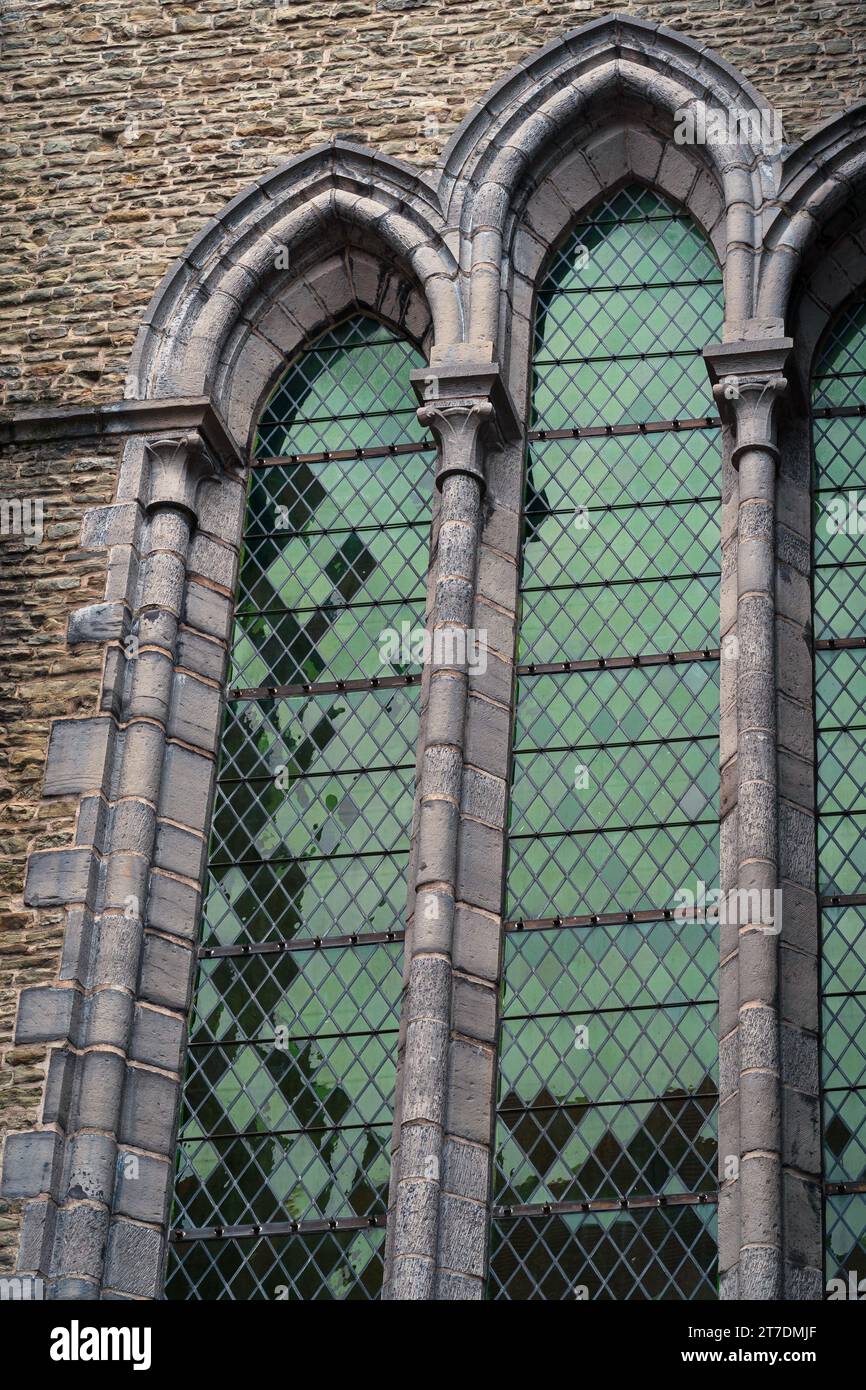Detail of an old church's large green arched glass window. Stained ...