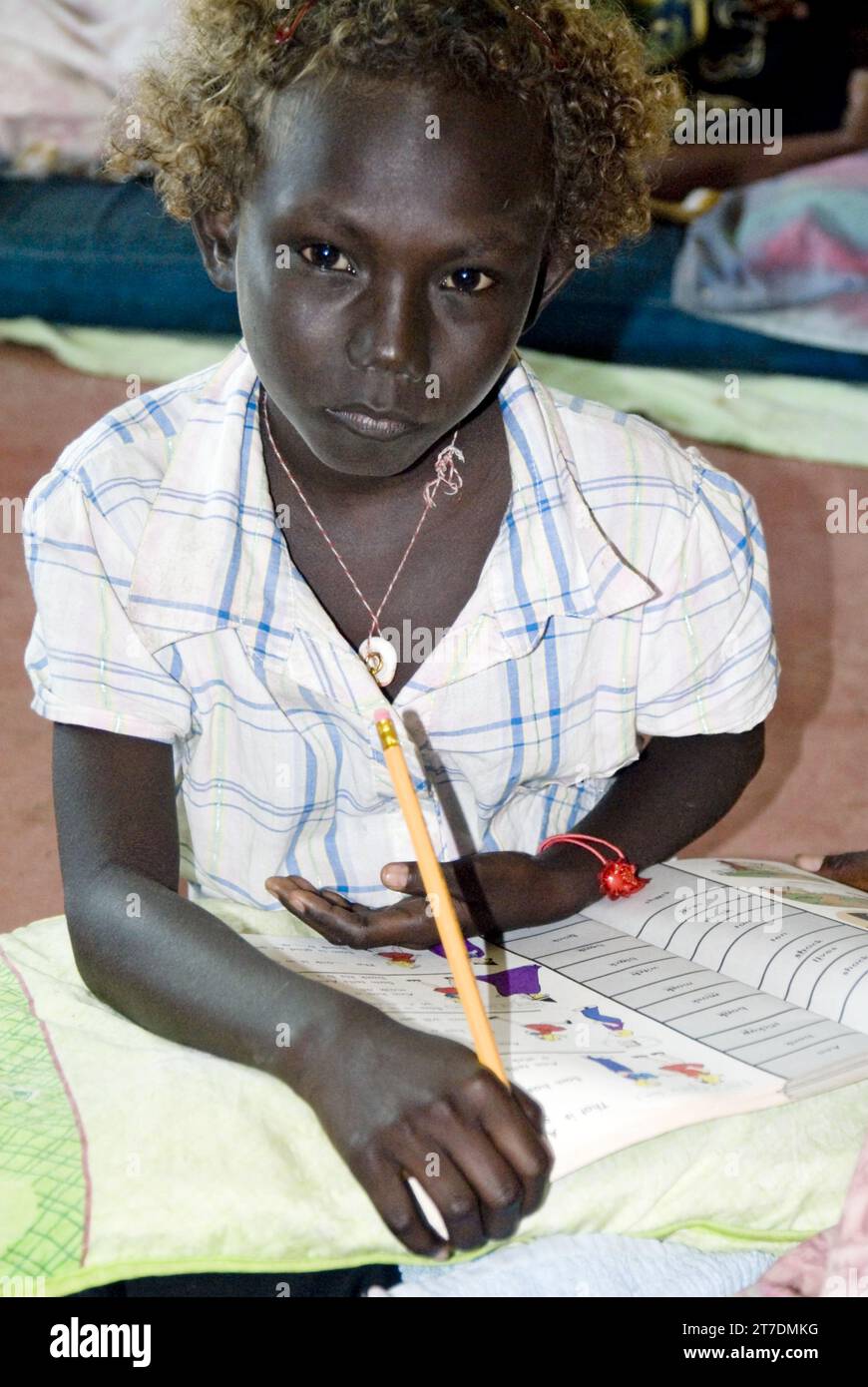 Young Solomon Islander girl completes her school homework aboard the M ...