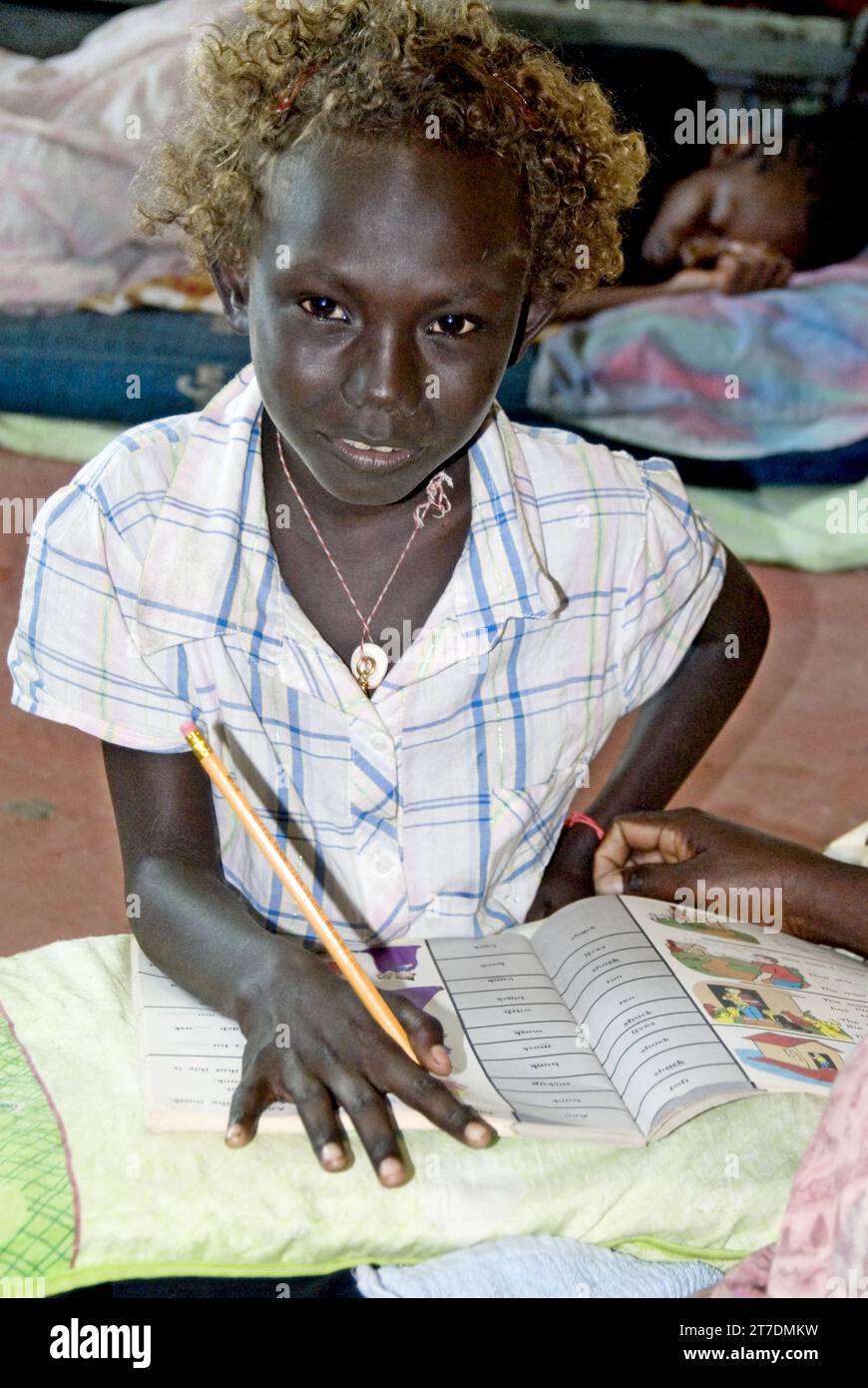 Young Solomon Islander girl completes her school homework aboard the M ...