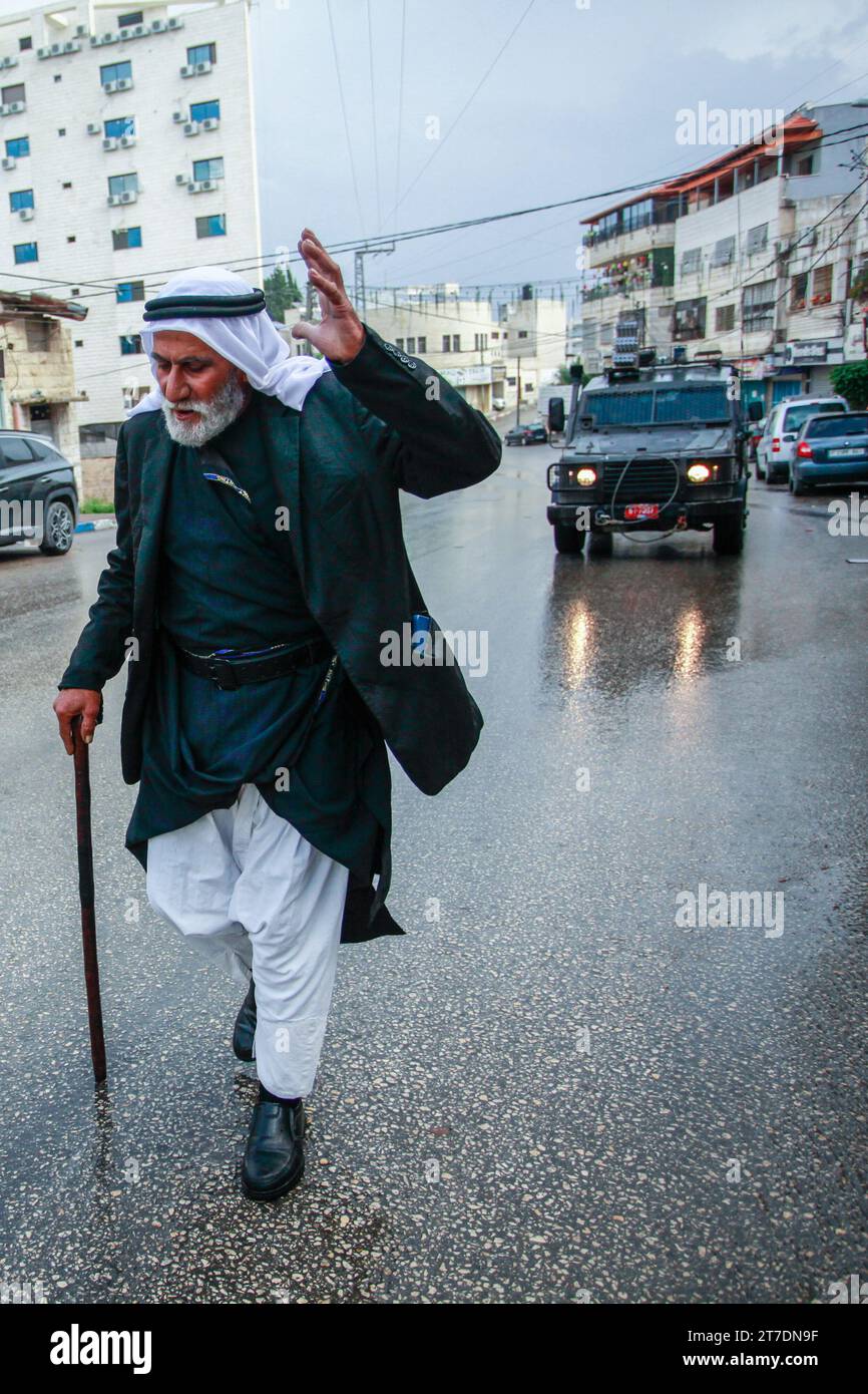 Tulkarm, Palestine. 14th Nov, 2023. A Palestinian man walks in front of ...