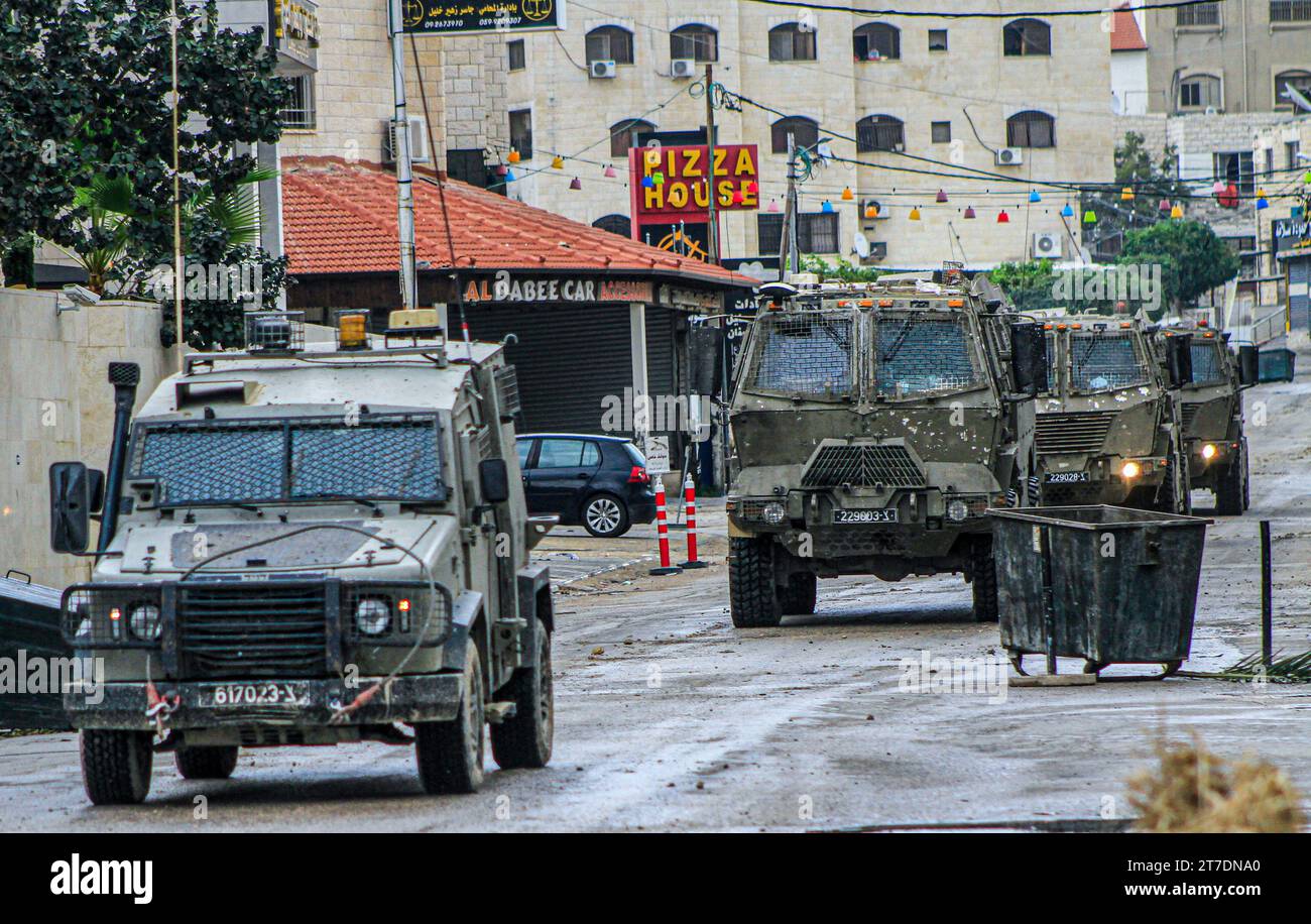 Tulkarm, Palestine. 14th Nov, 2023. Israeli military vehicles drive ...