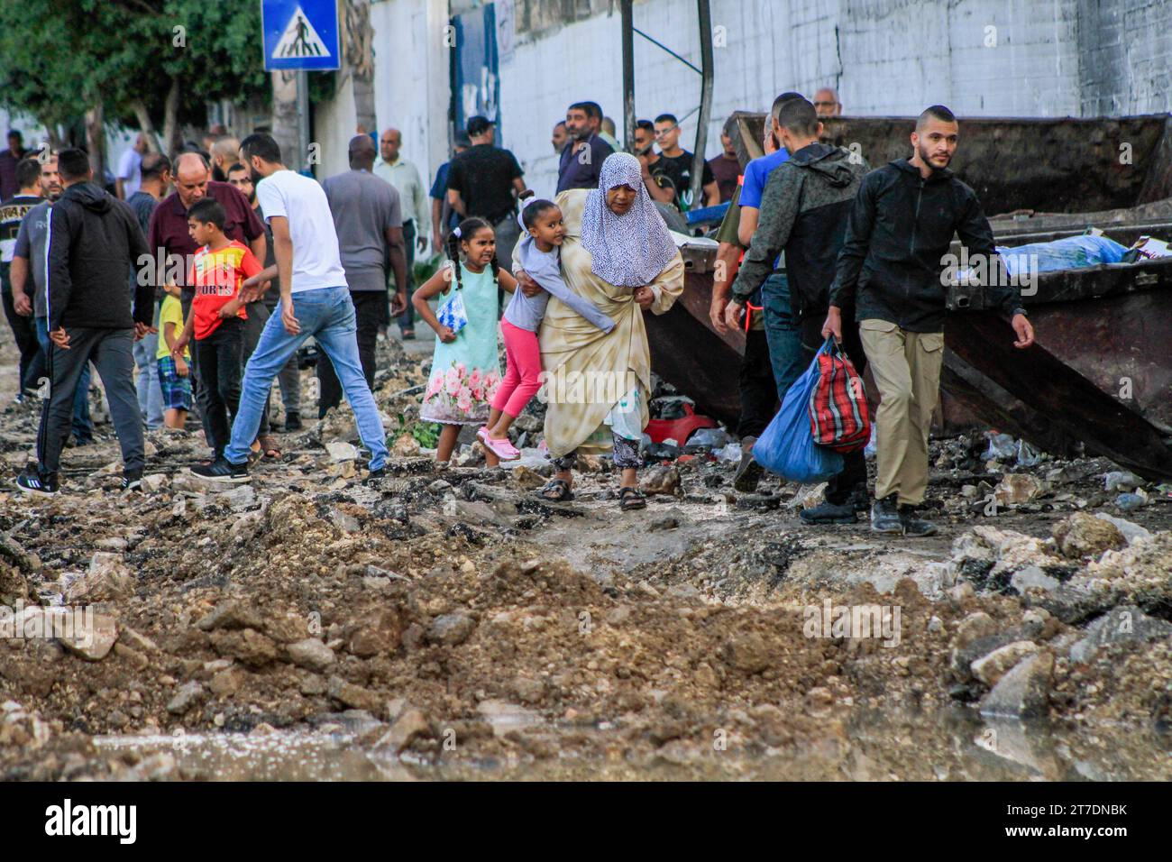 Tulkarm, Palestine. 14th Nov, 2023. Palestinians stand by a road ...